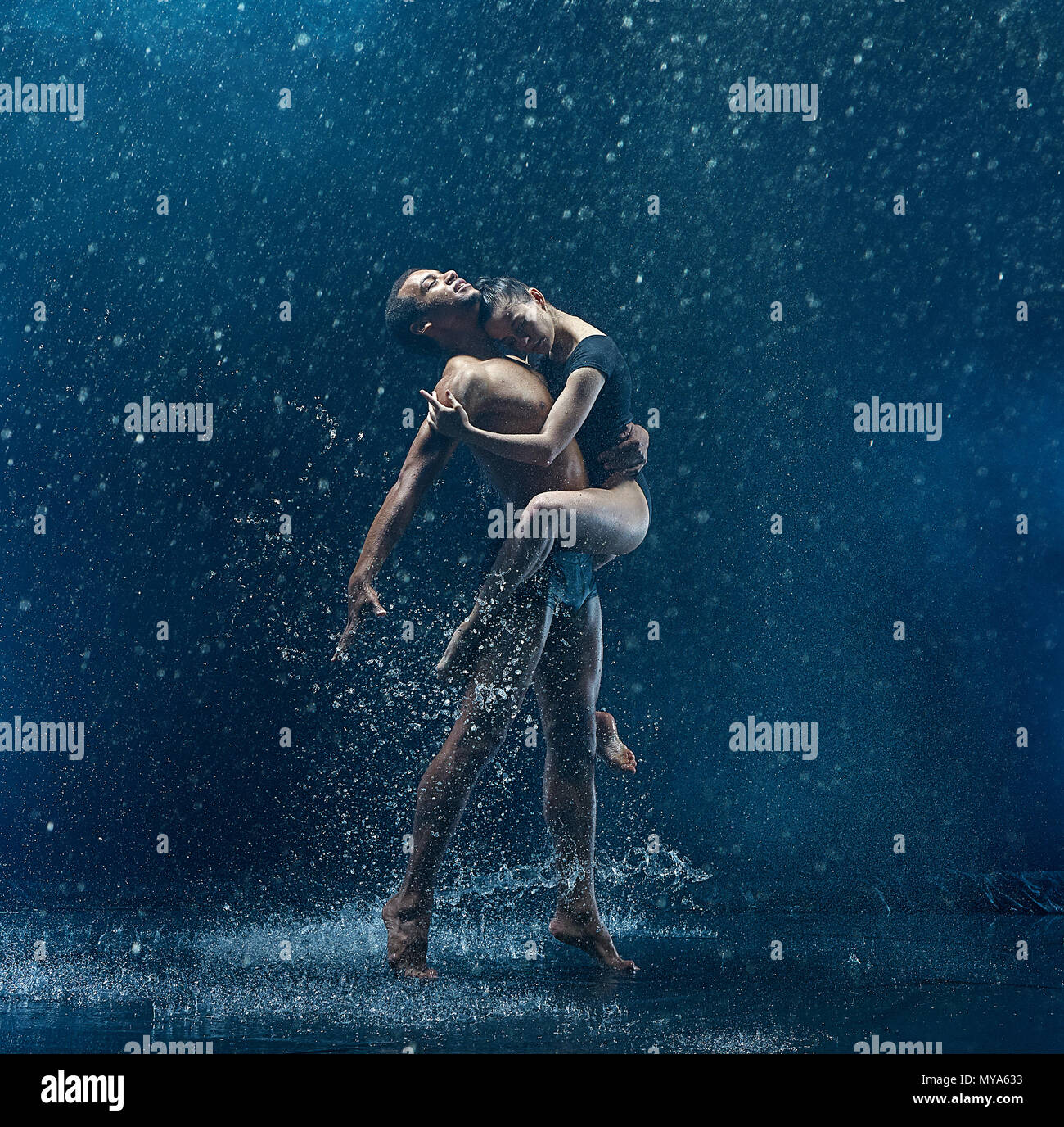 Young couple of ballet dancers dancing under water drops Stock Photo ...