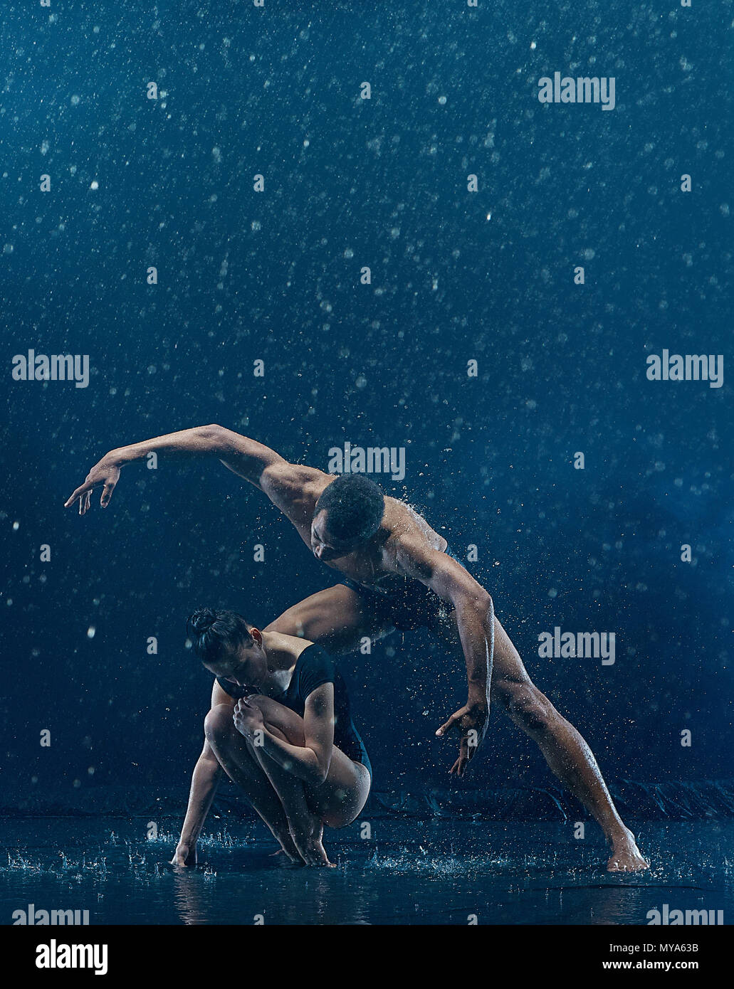 Young couple of ballet dancers dancing under water drops Stock Photo ...