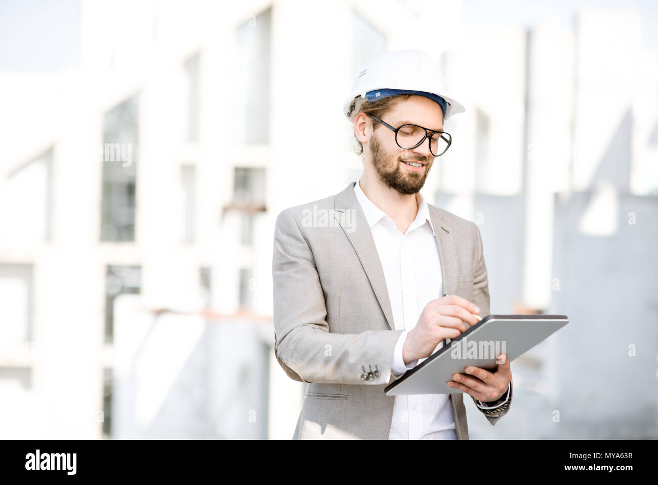 Engineer with tablet on the structure Stock Photo - Alamy