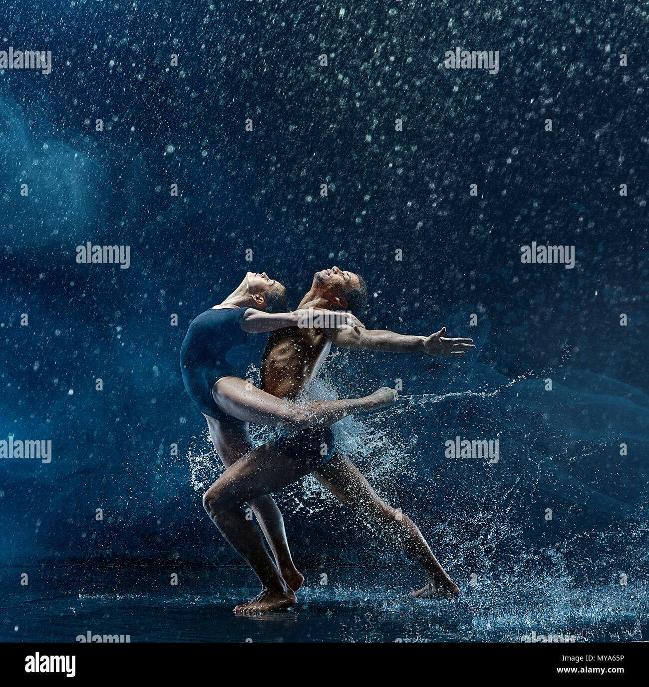 Young couple of ballet dancers dancing under water drops Stock Photo ...