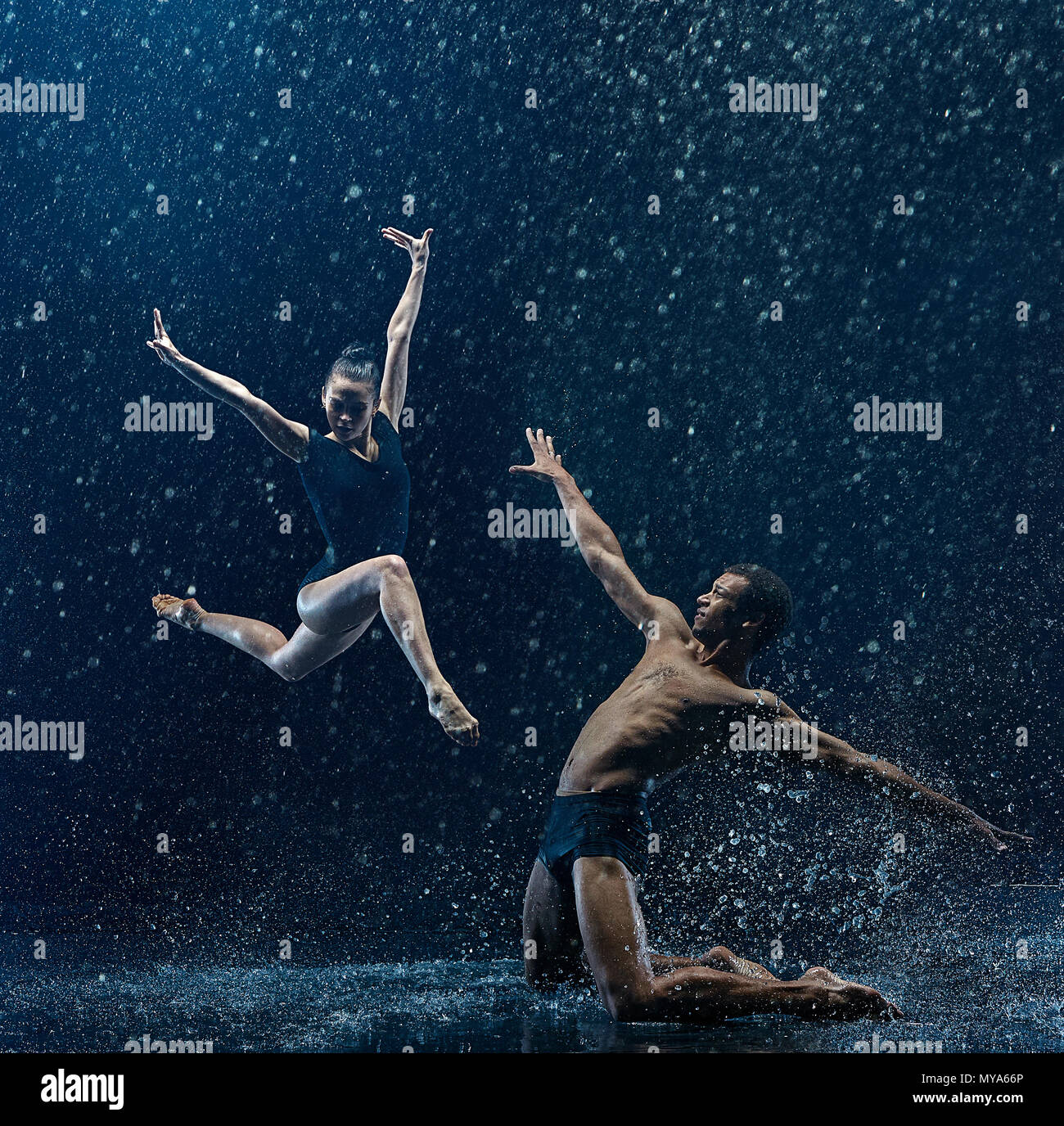 Young couple of ballet dancers dancing under water drops Stock Photo ...