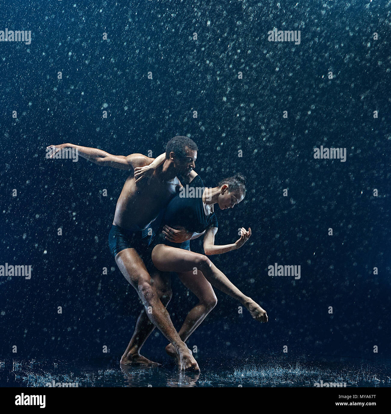 Young couple of ballet dancers dancing under water drops Stock Photo ...