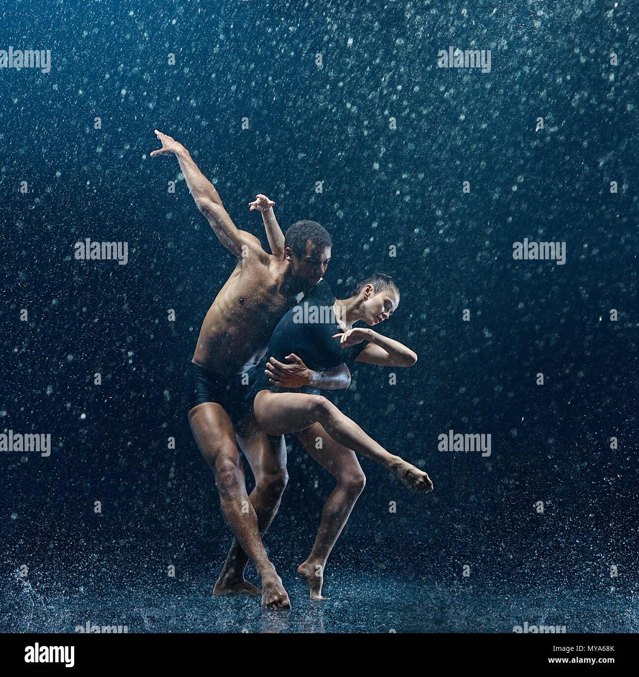 Young couple of ballet dancers dancing under water drops Stock Photo ...