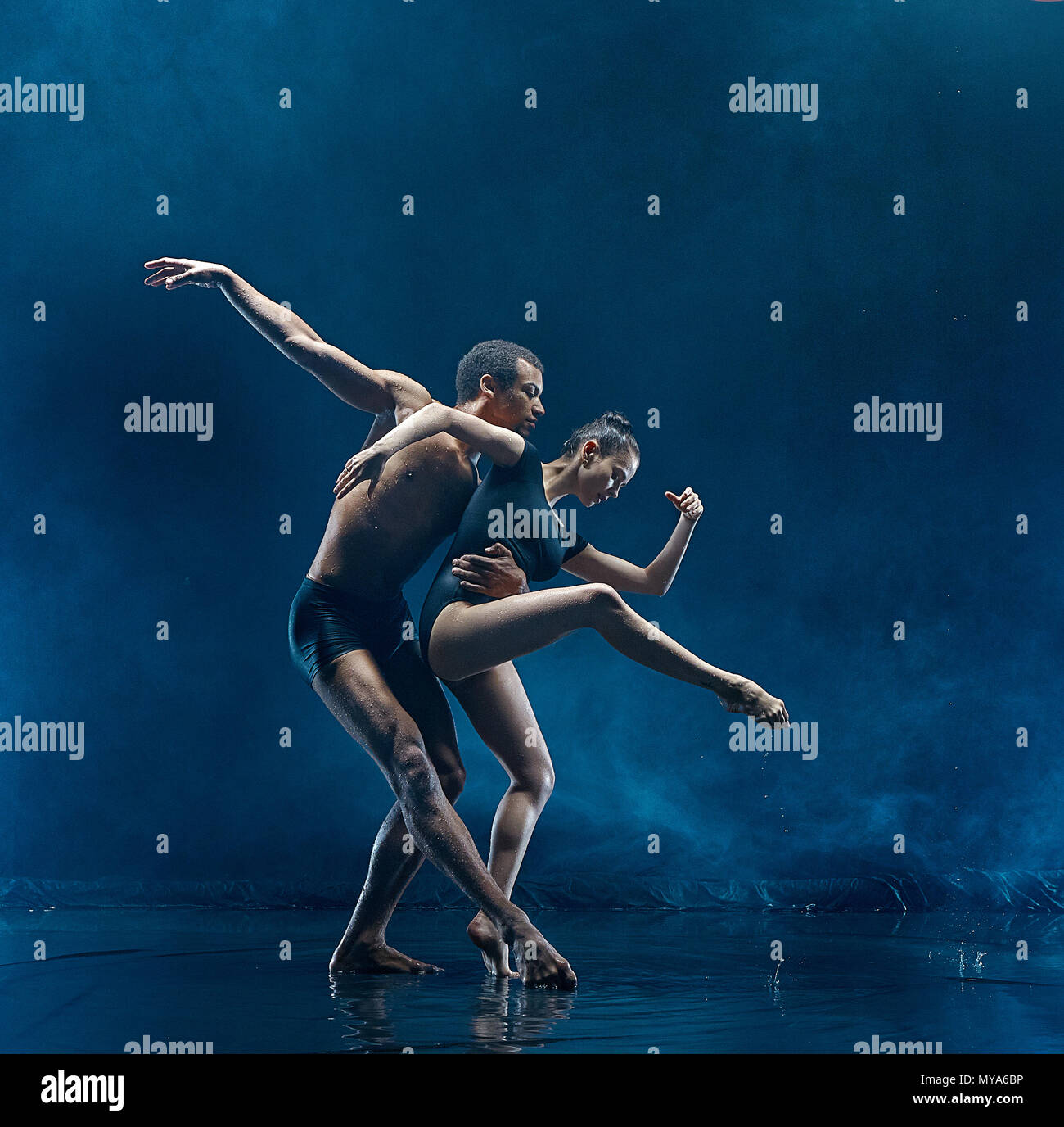 Young couple of ballet dancers dancing under water drops Stock Photo ...