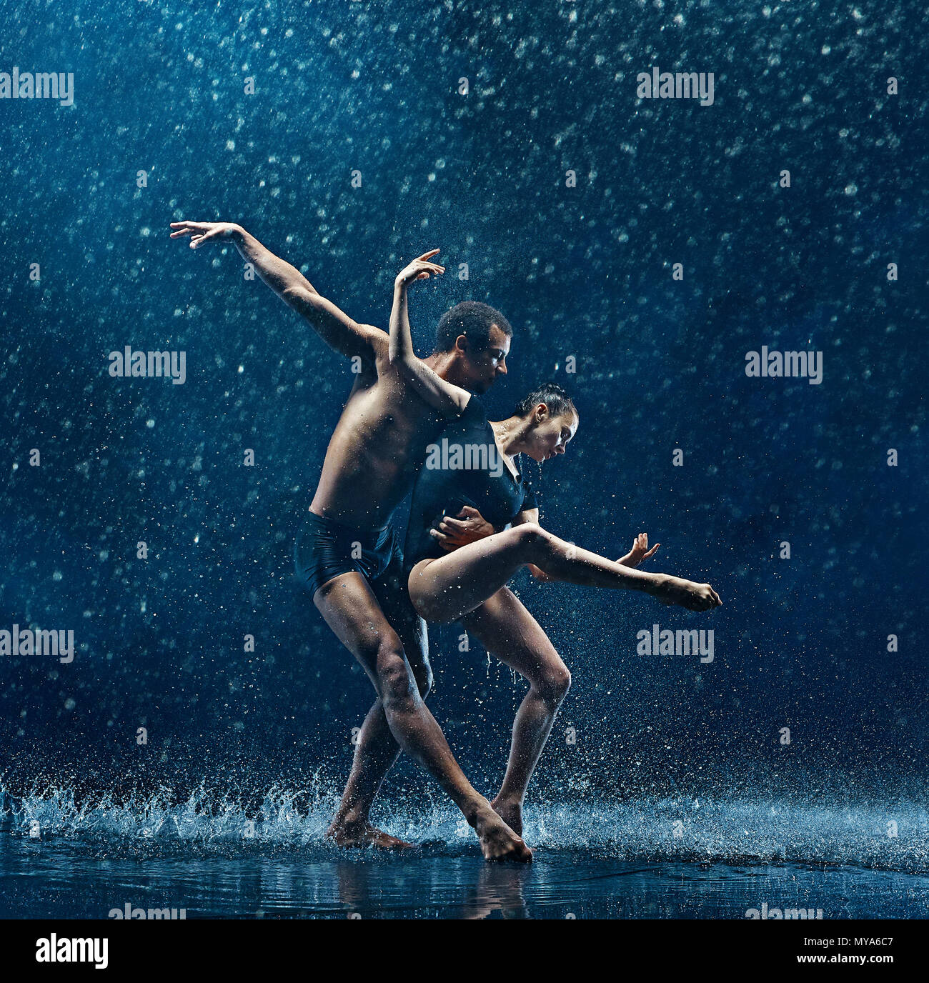 Young couple of ballet dancers dancing under water drops Stock Photo ...