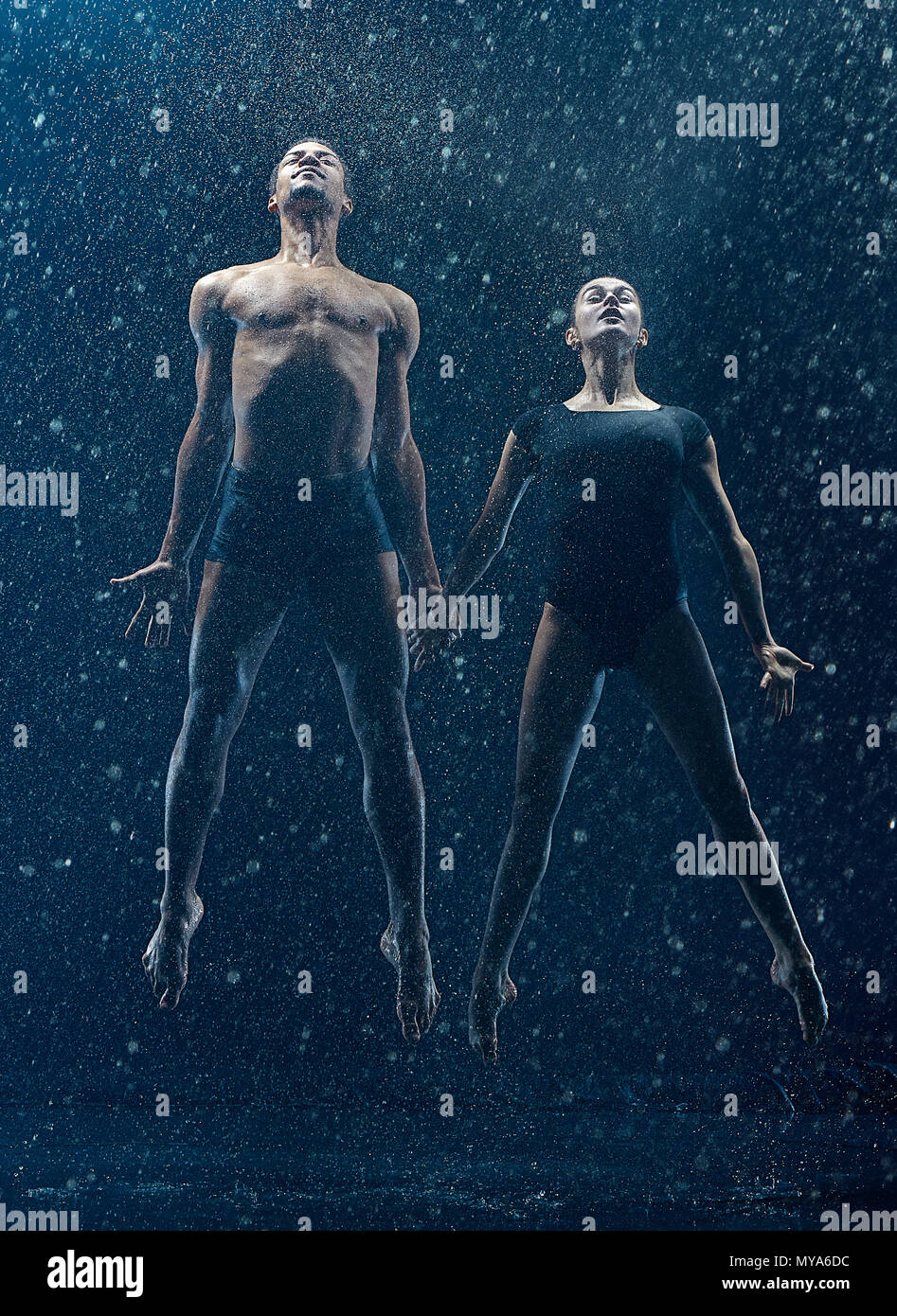 Young couple of ballet dancers dancing under water drops Stock Photo ...