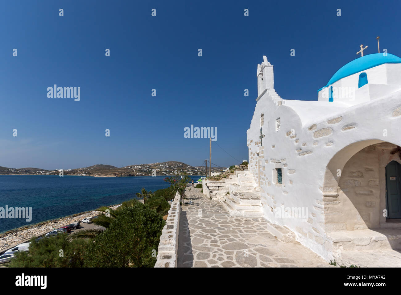 Amazing seascape with White church with blue roof in town of Parakia ...