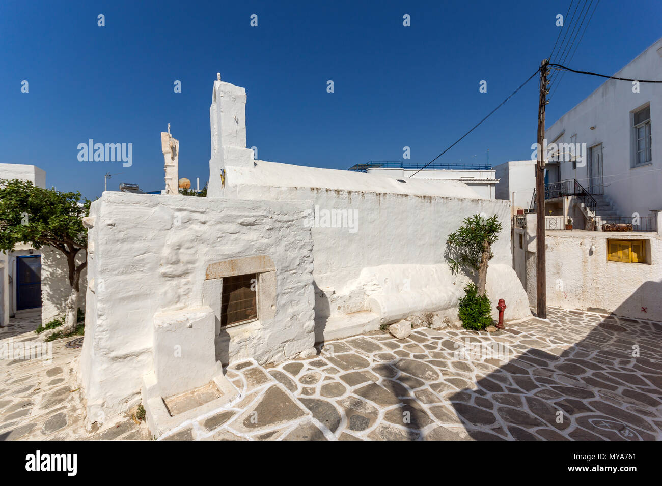 White church with blue roof in town of Parakia, Paros island, Cyclades ...