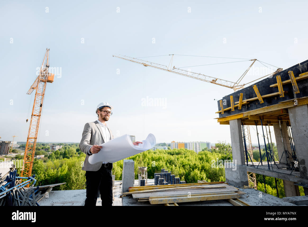 Man with house drawings on the structure Stock Photo - Alamy