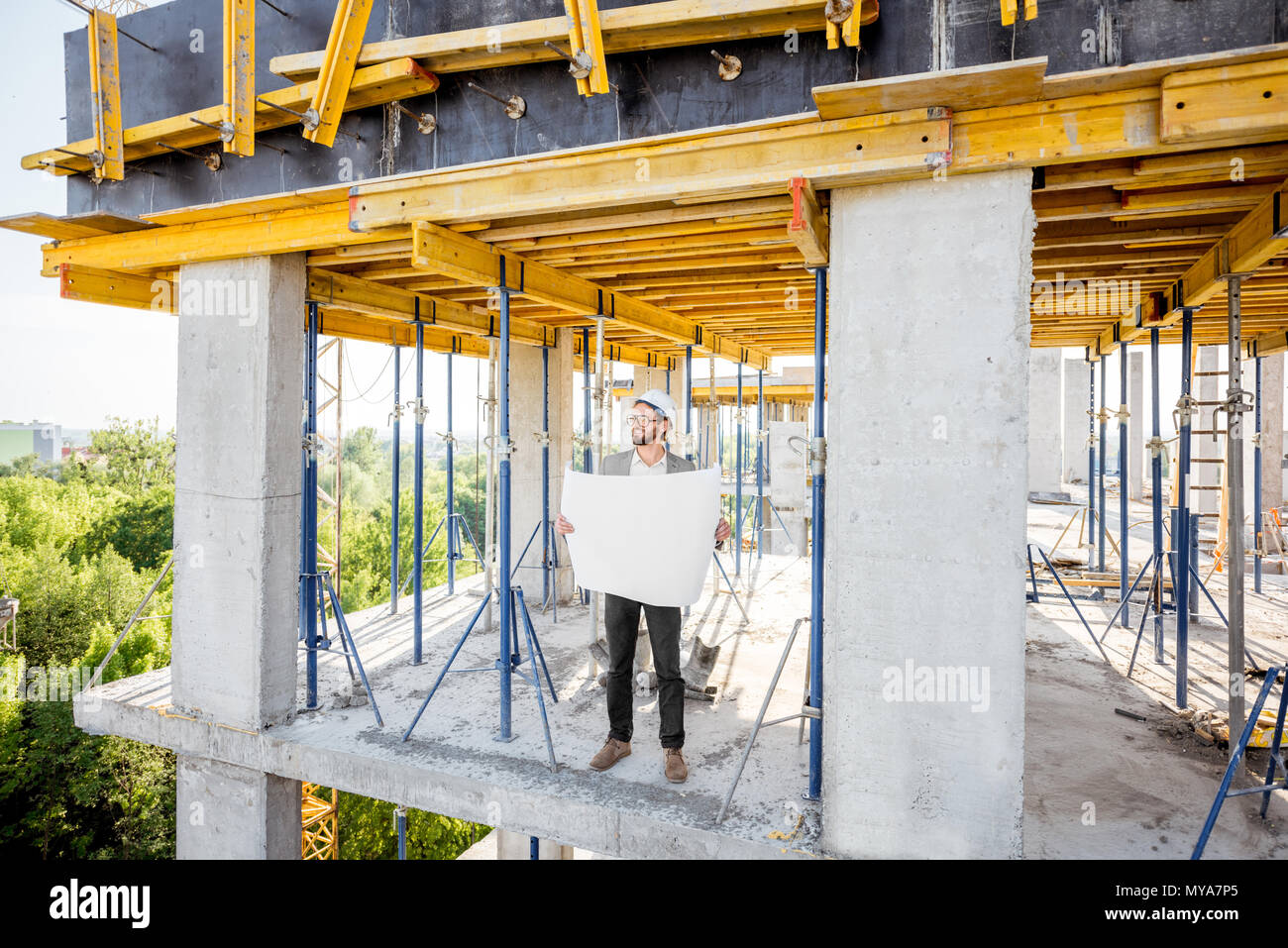 Man with house drawings on the structure Stock Photo - Alamy