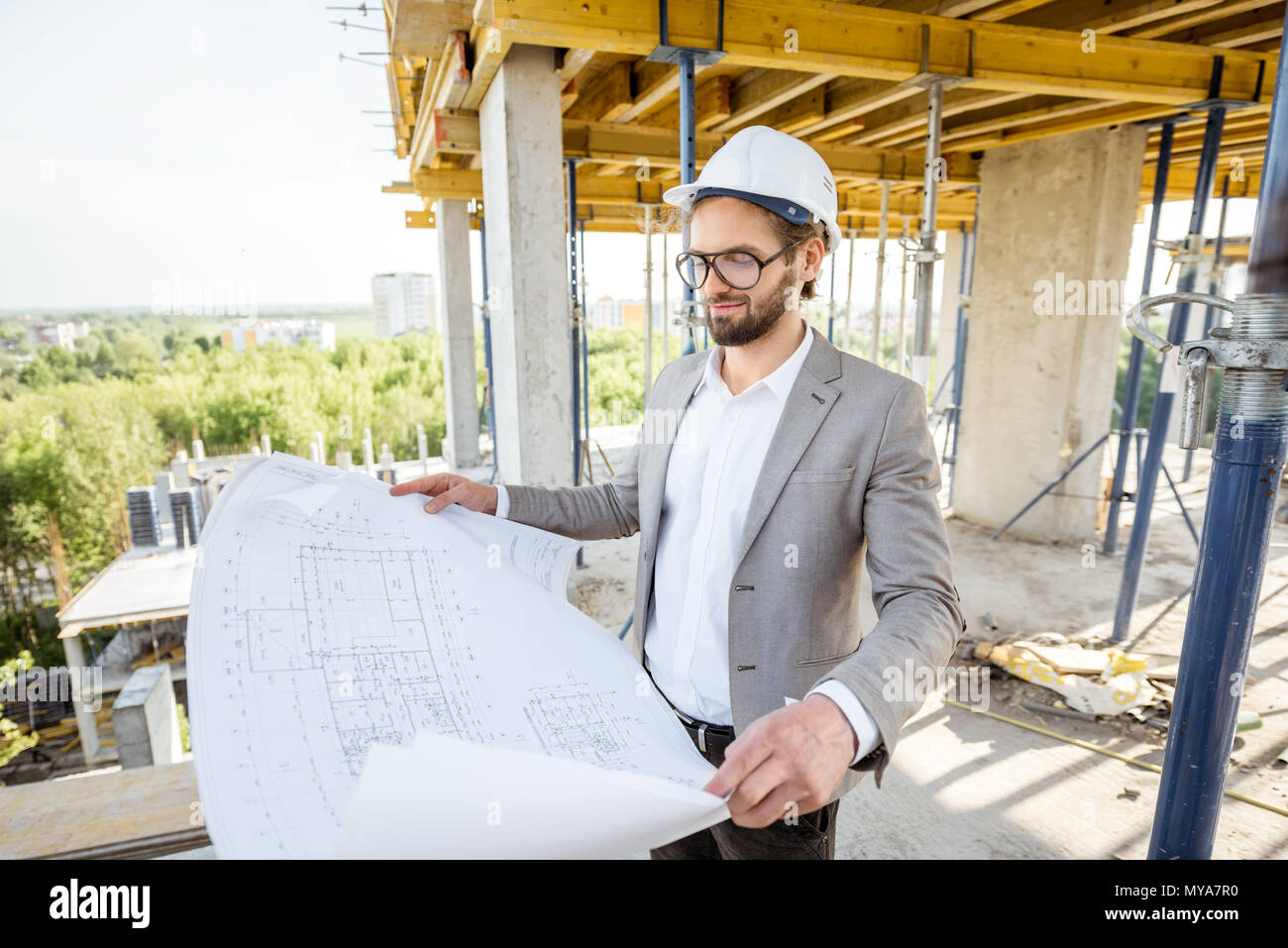 Man with house drawings on the structure Stock Photo - Alamy