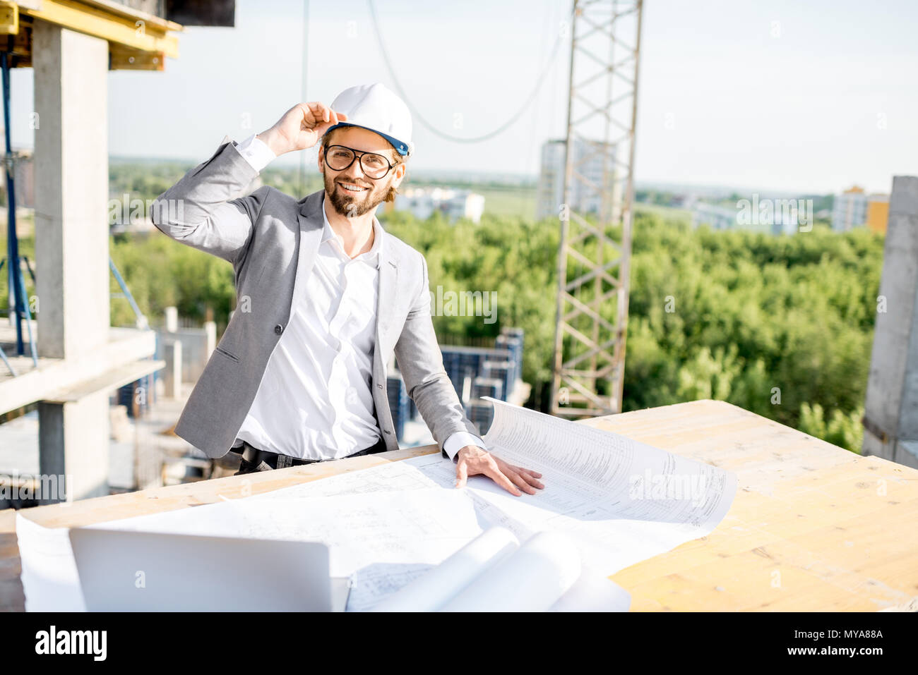 Engineer with drawings on the structure Stock Photo - Alamy