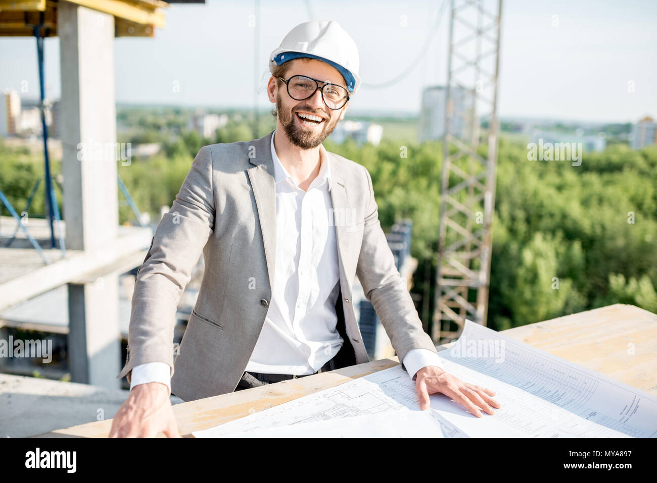 Engineer with drawings on the structure Stock Photo - Alamy