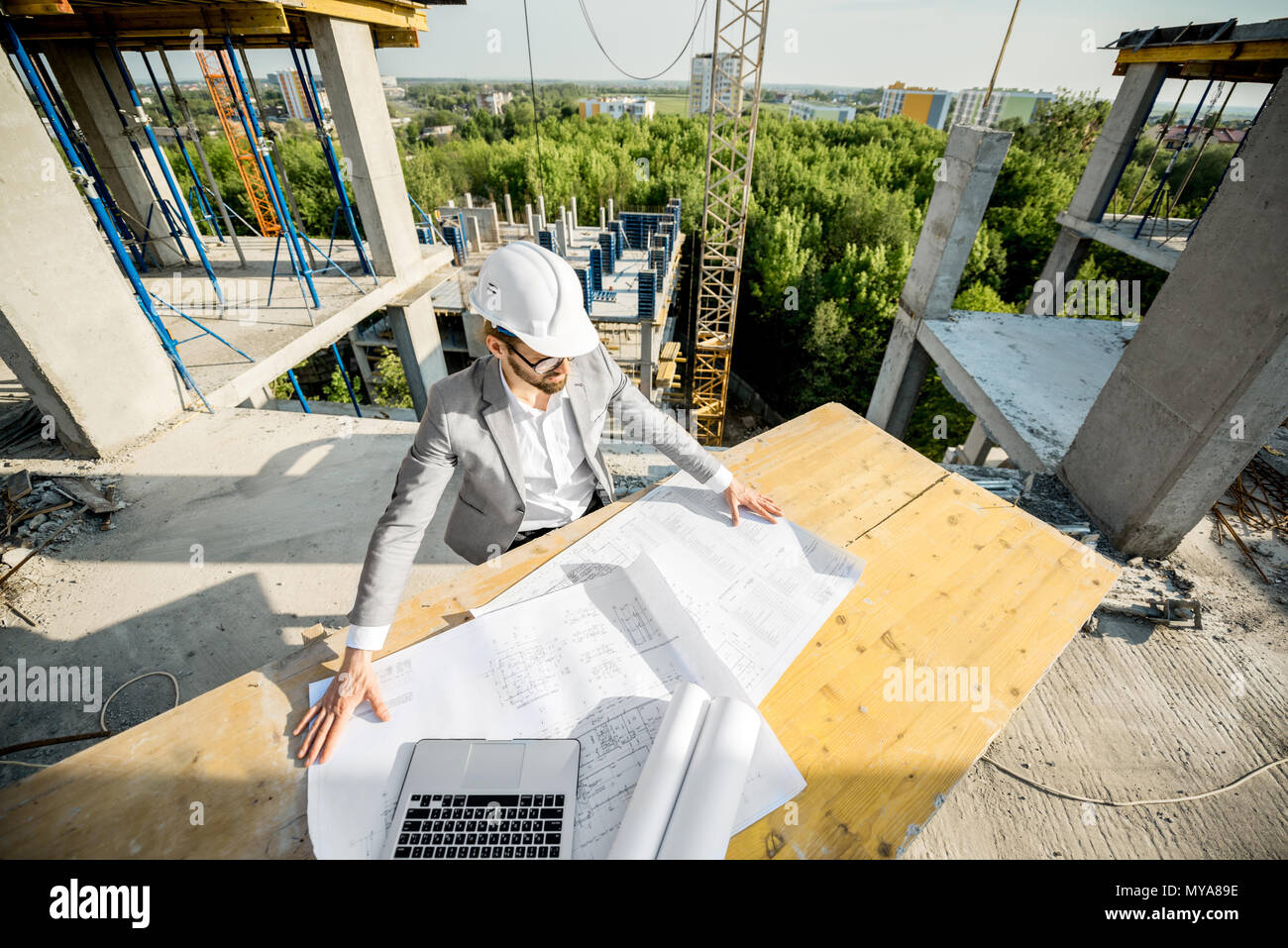 Engineer with drawings on the structure Stock Photo - Alamy