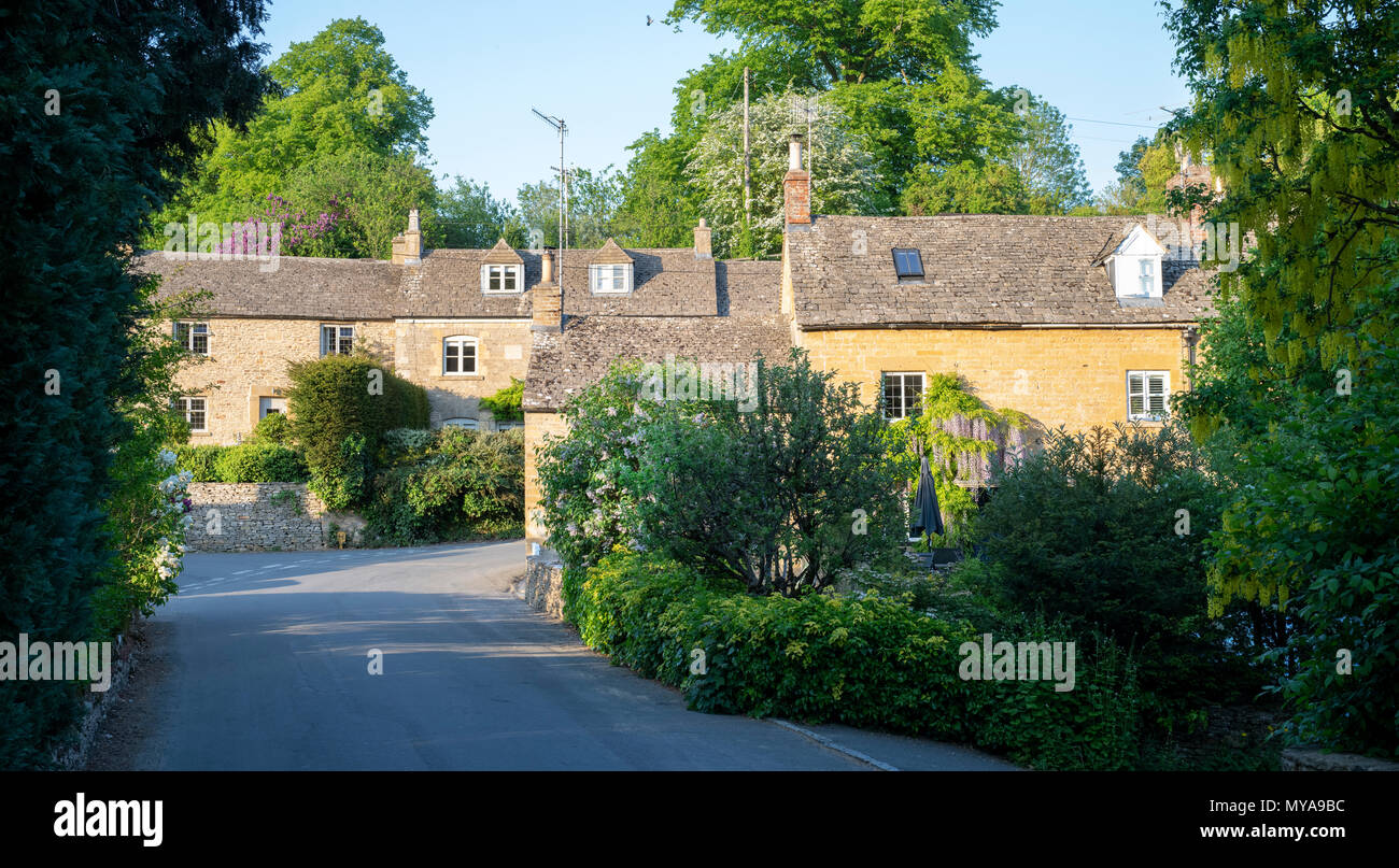 Cotswold cottages in the village of Naunton in the late evening spring ...