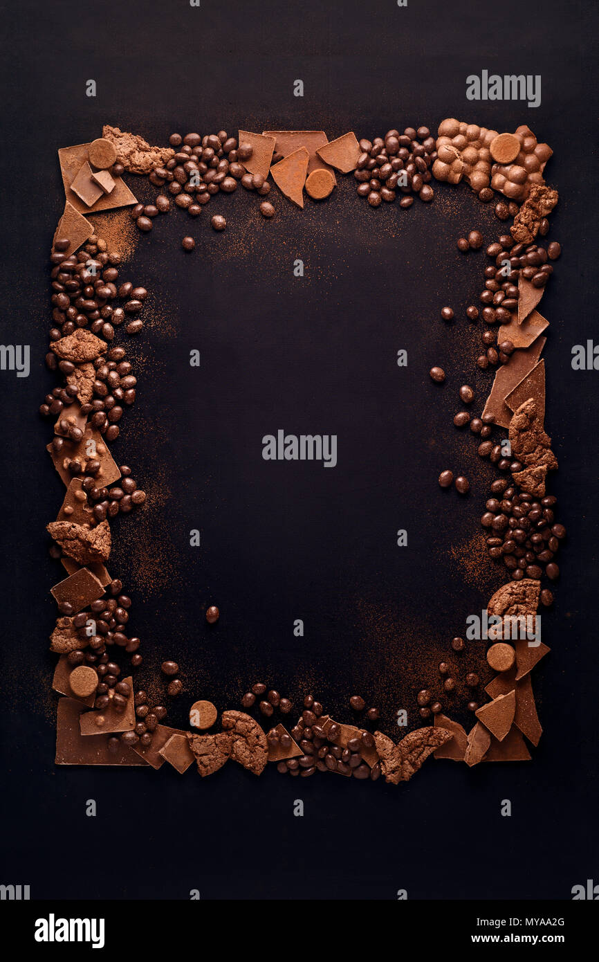 Creative concept photo of frame made of chocolate on black background ...