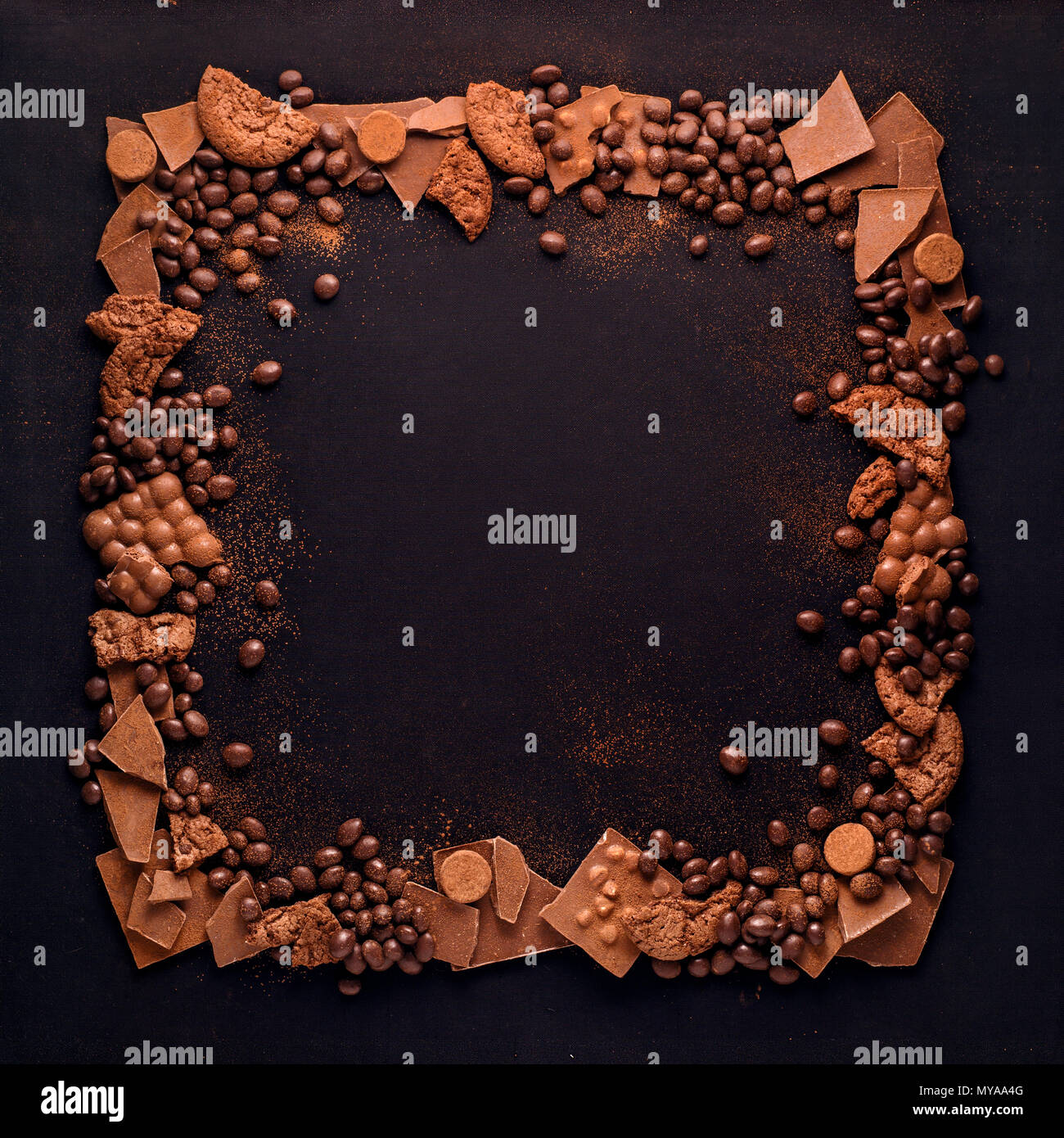 Creative concept photo of frame made of chocolate on black background ...