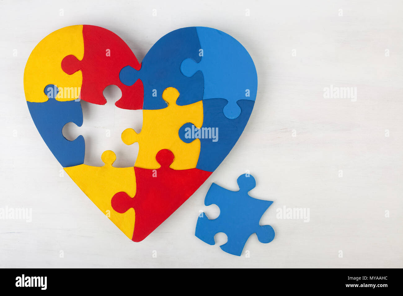 A colorful heart made of symbolic autism puzzle pieces Stock Photo - Alamy