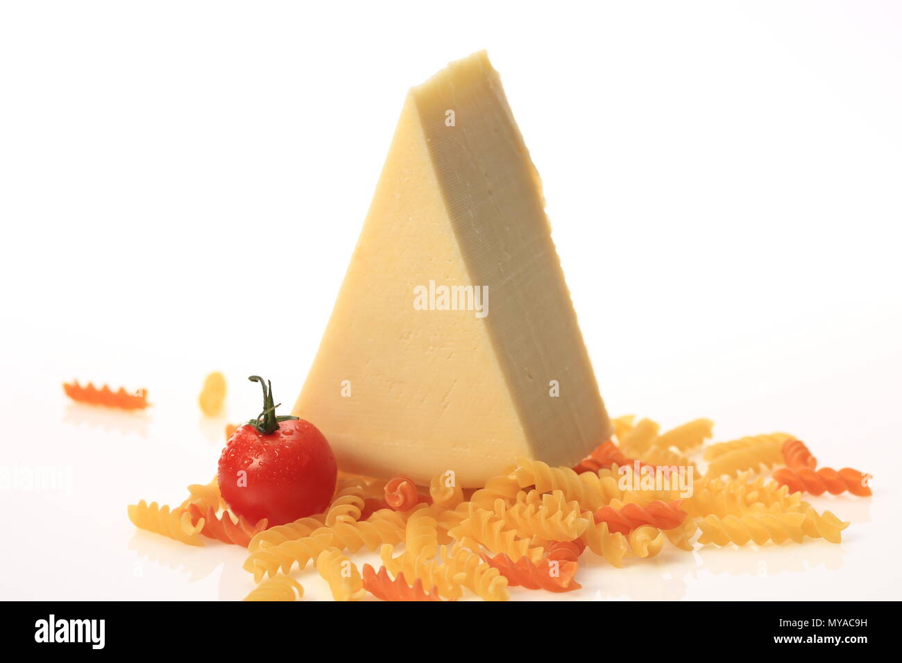 Block and triangle sliced cheese with a slice of tomato Stock Photo - Alamy