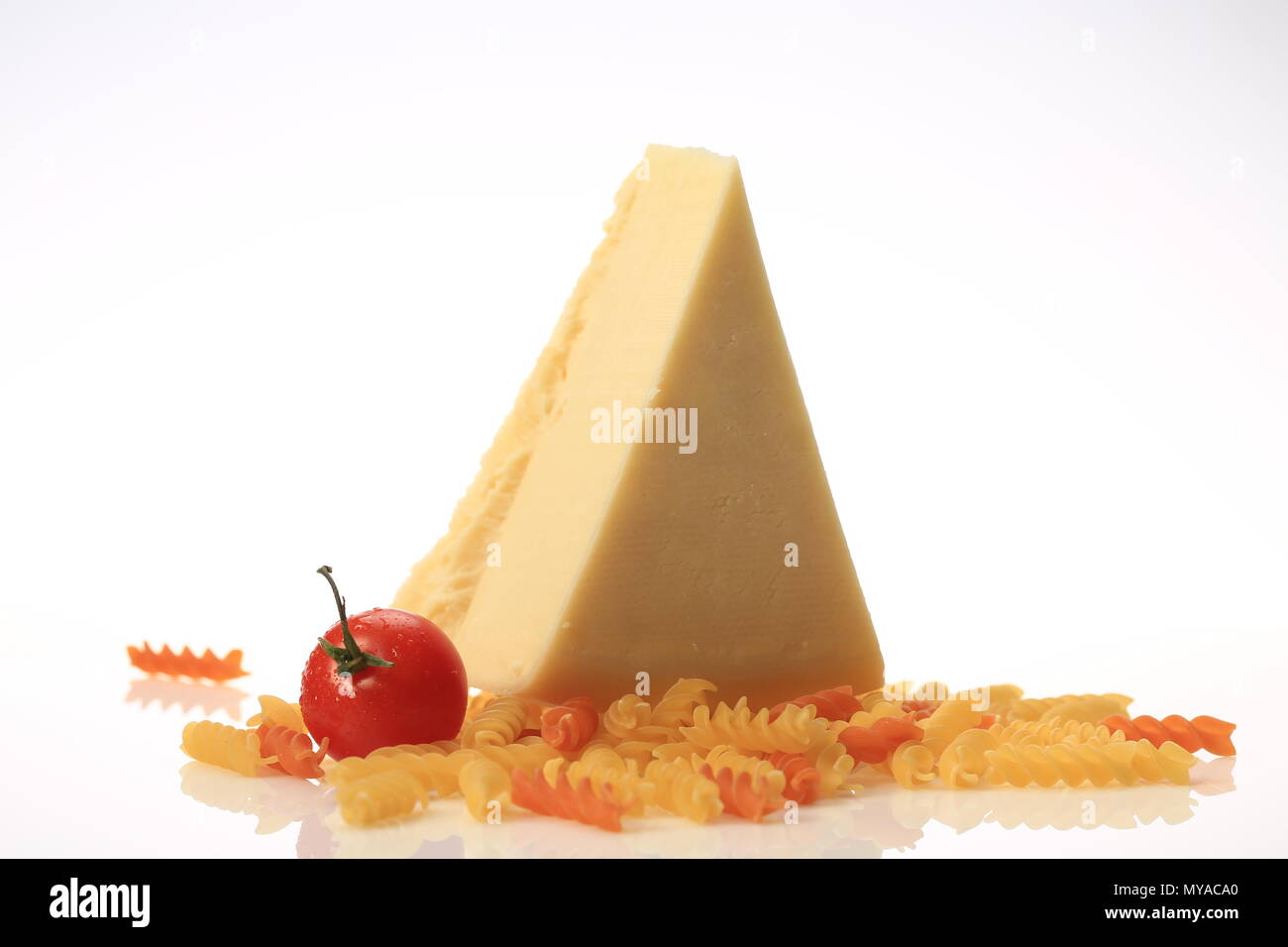 Block and triangle sliced cheese with a slice of tomato Stock Photo - Alamy