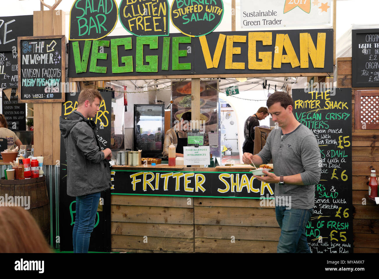 Veggie food stall and Fritter Shack sign in the Hay Festival Food Hall ...