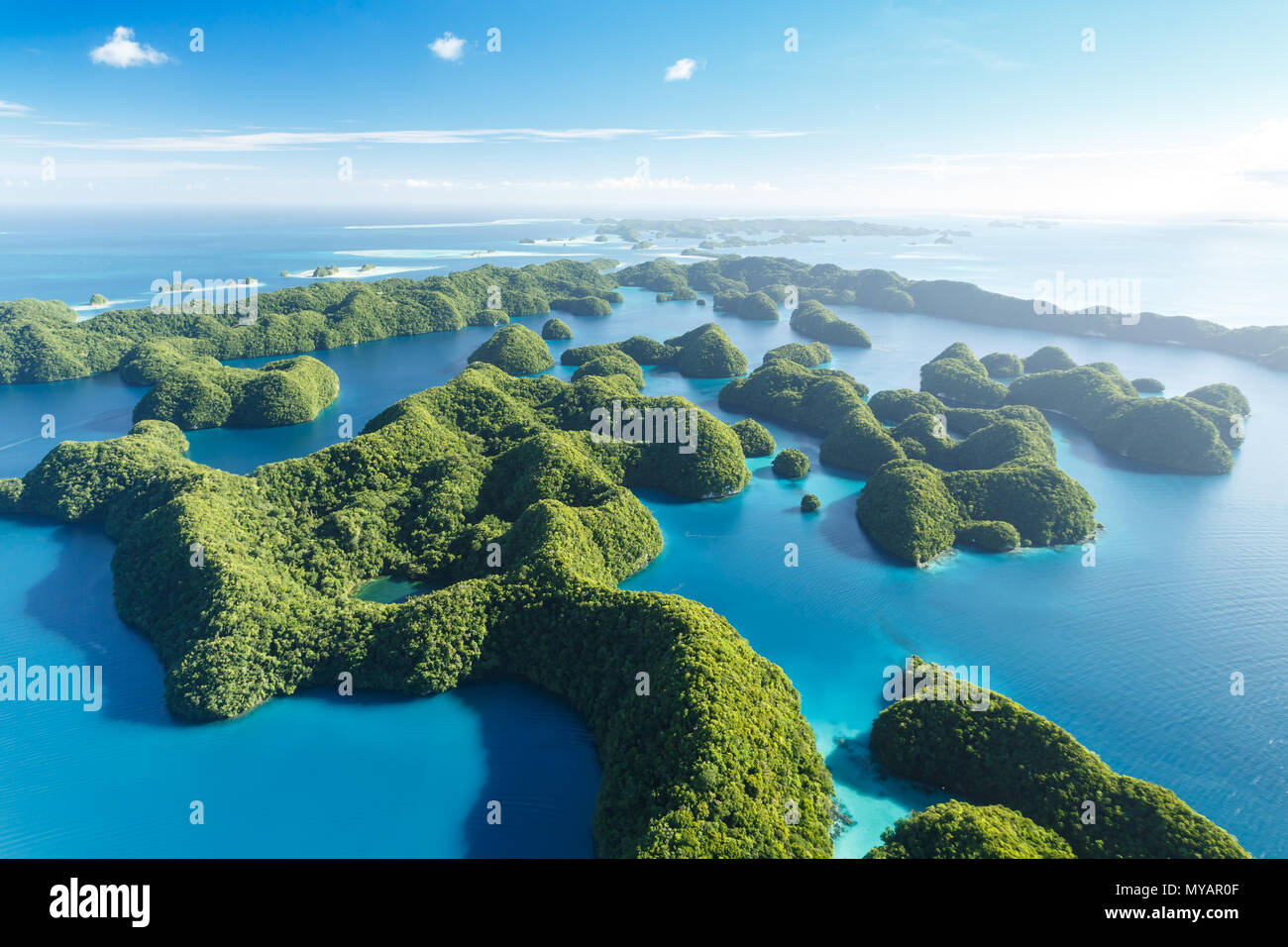 Aerial view of a lush tropical island atoll in the turquoise blue ...