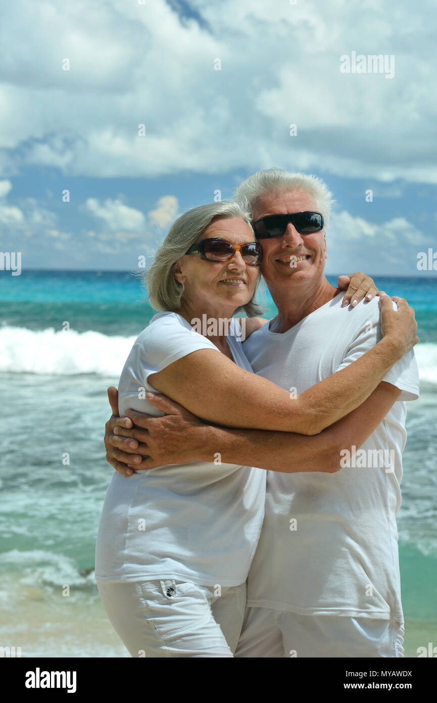 Happy elderly couple hugging Stock Photo - Alamy