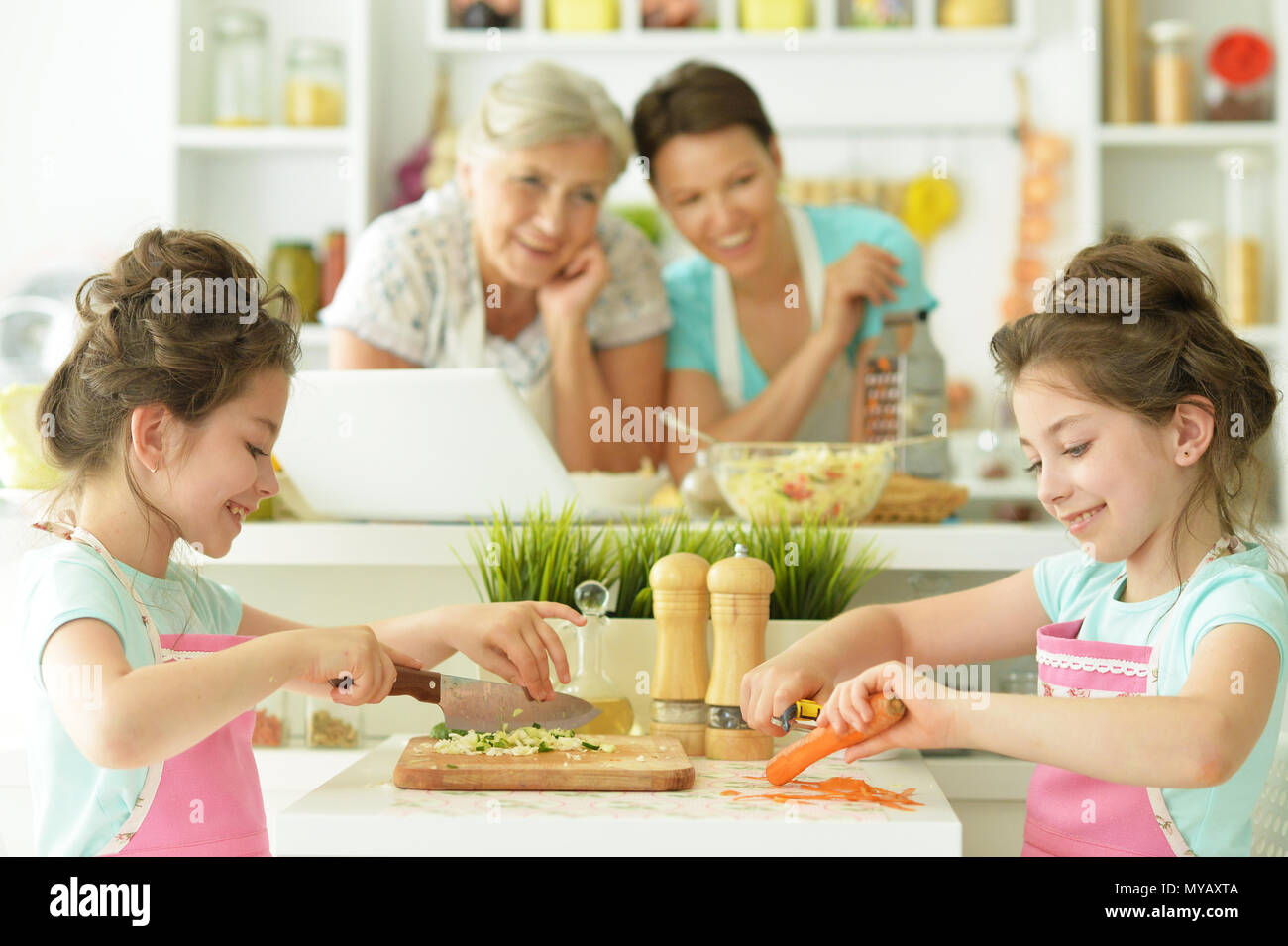 Family in the kitchen cook Stock Photo - Alamy