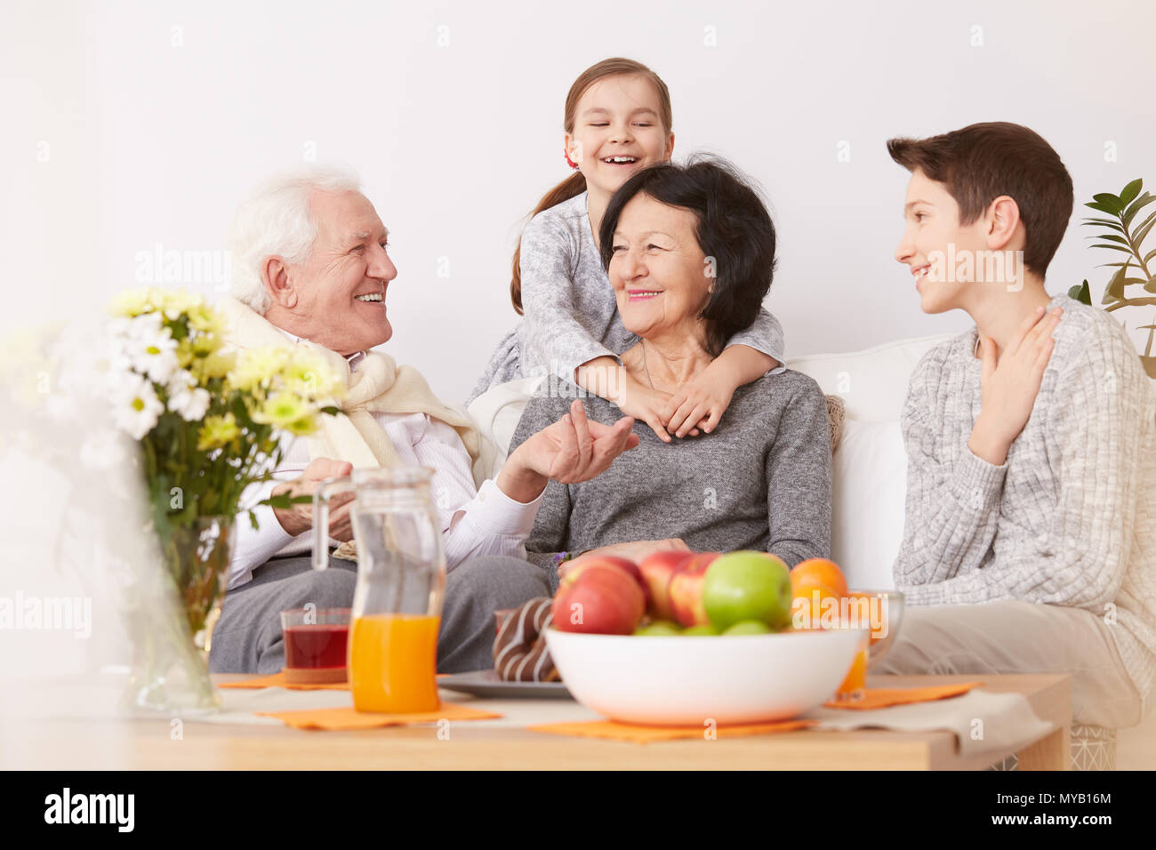 Happy family spending free time together in a living room Stock Photo ...