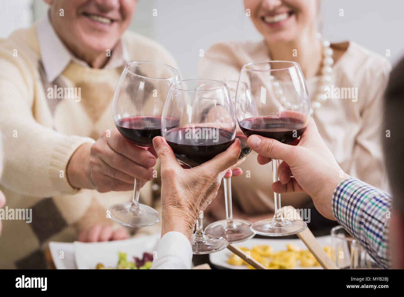 Happy family toasting, holding glasses with wine, smiling Stock Photo ...