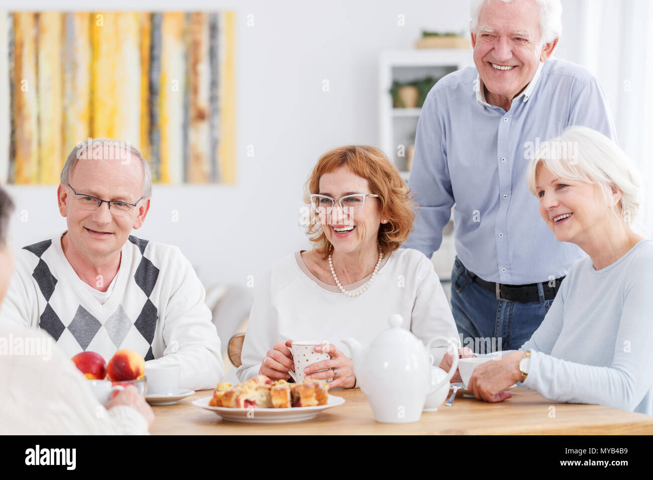 Group of happy seniors meeting at a tea party Stock Photo - Alamy