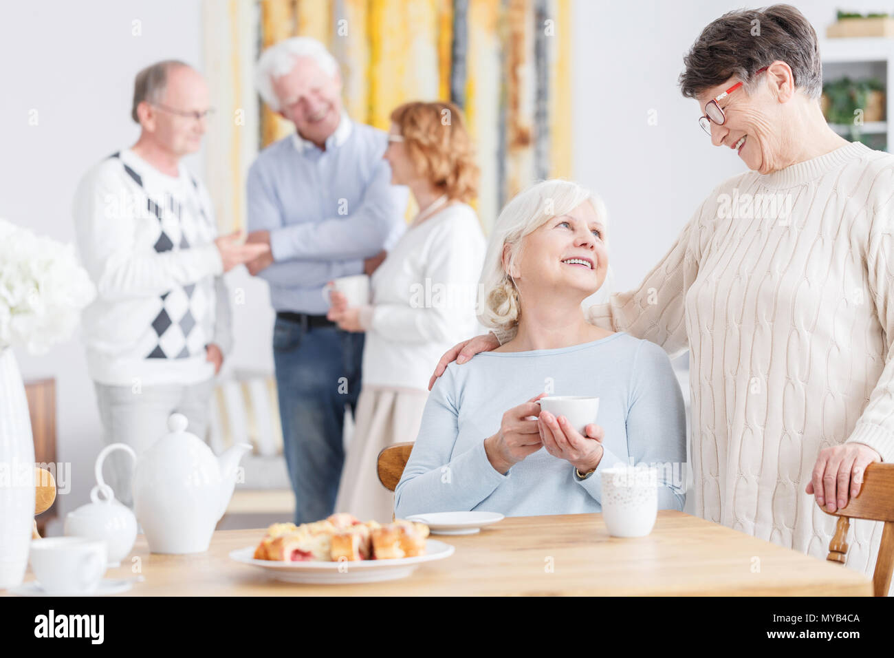 Elderly friends on a tea party at neighbor's home Stock Photo - Alamy