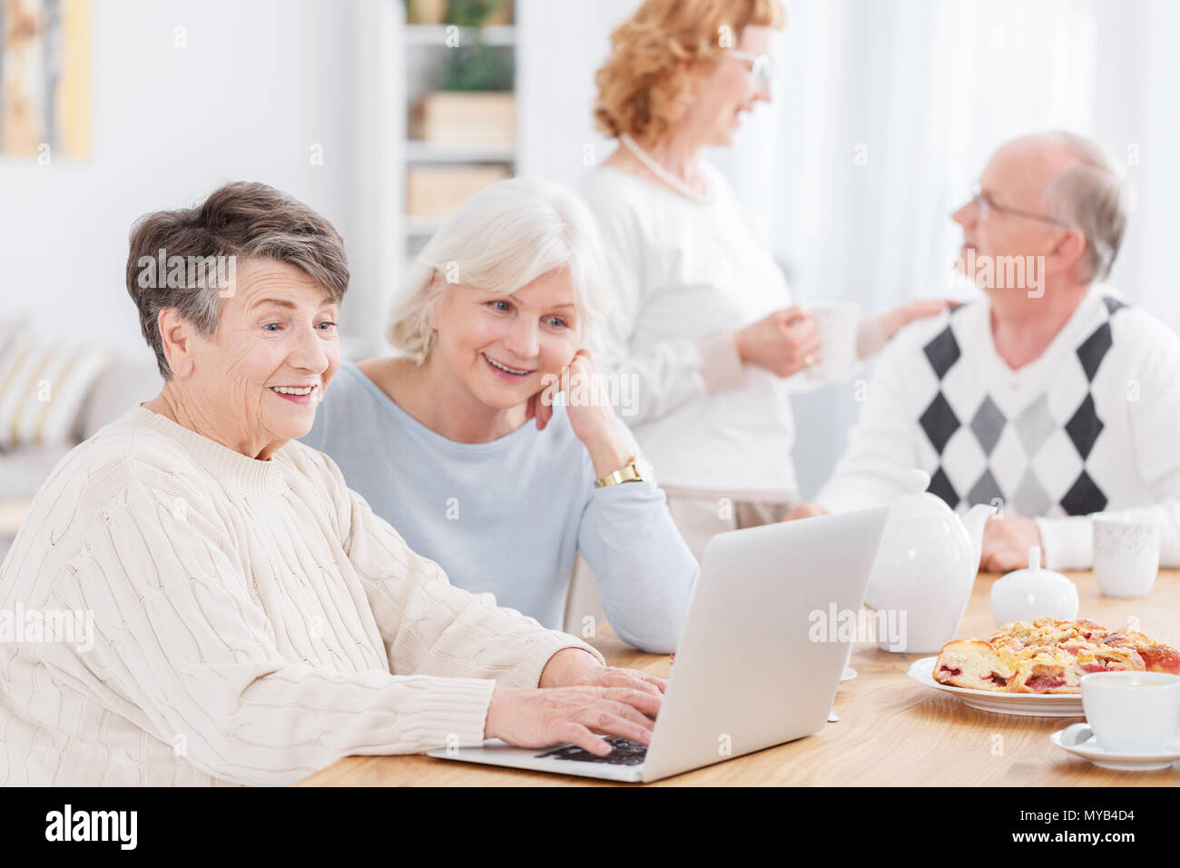 Two senior women using new technology in nursing home Stock Photo - Alamy