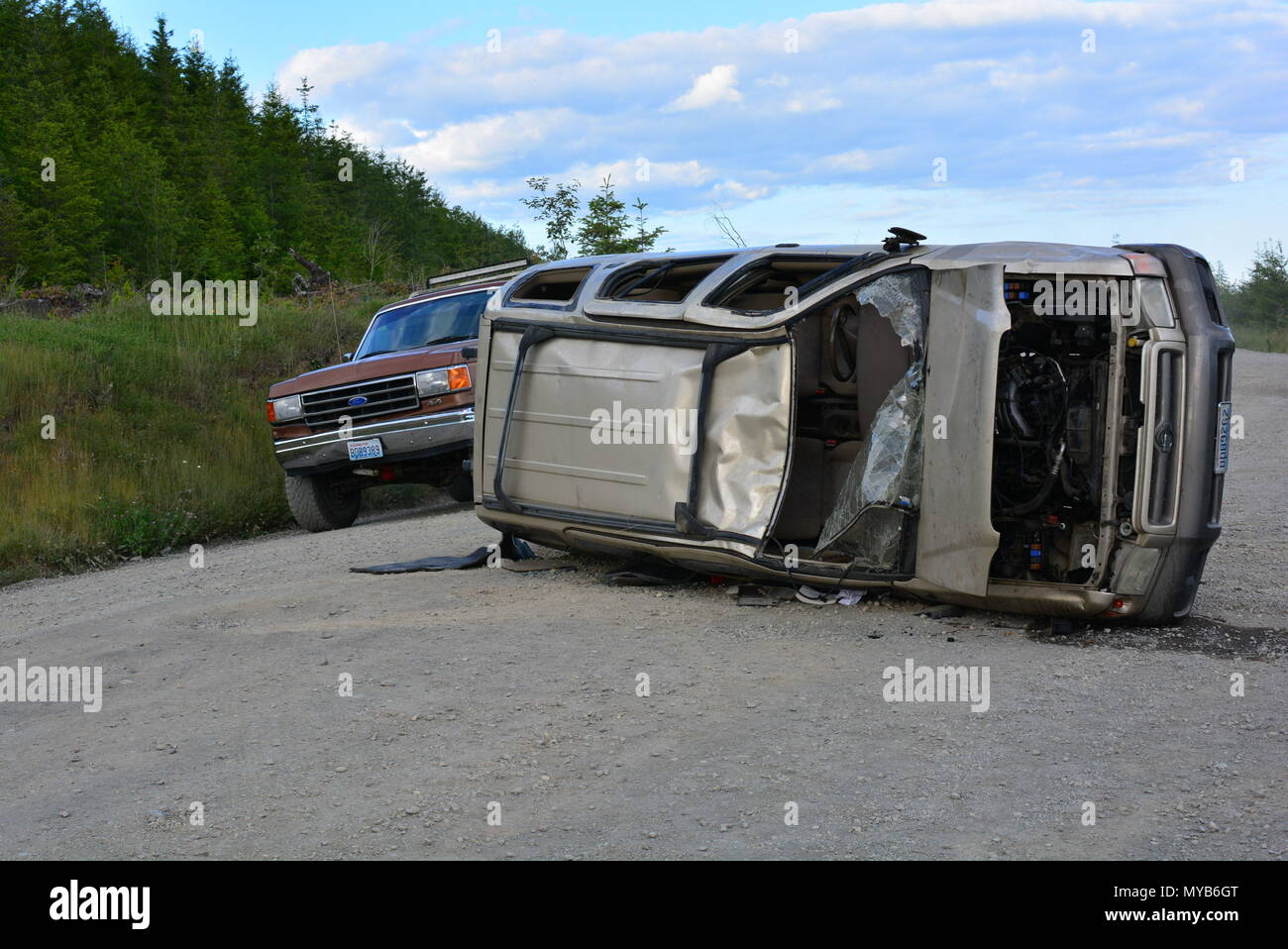 SUV car accident on it's side on a dirt road Stock Photo - Alamy