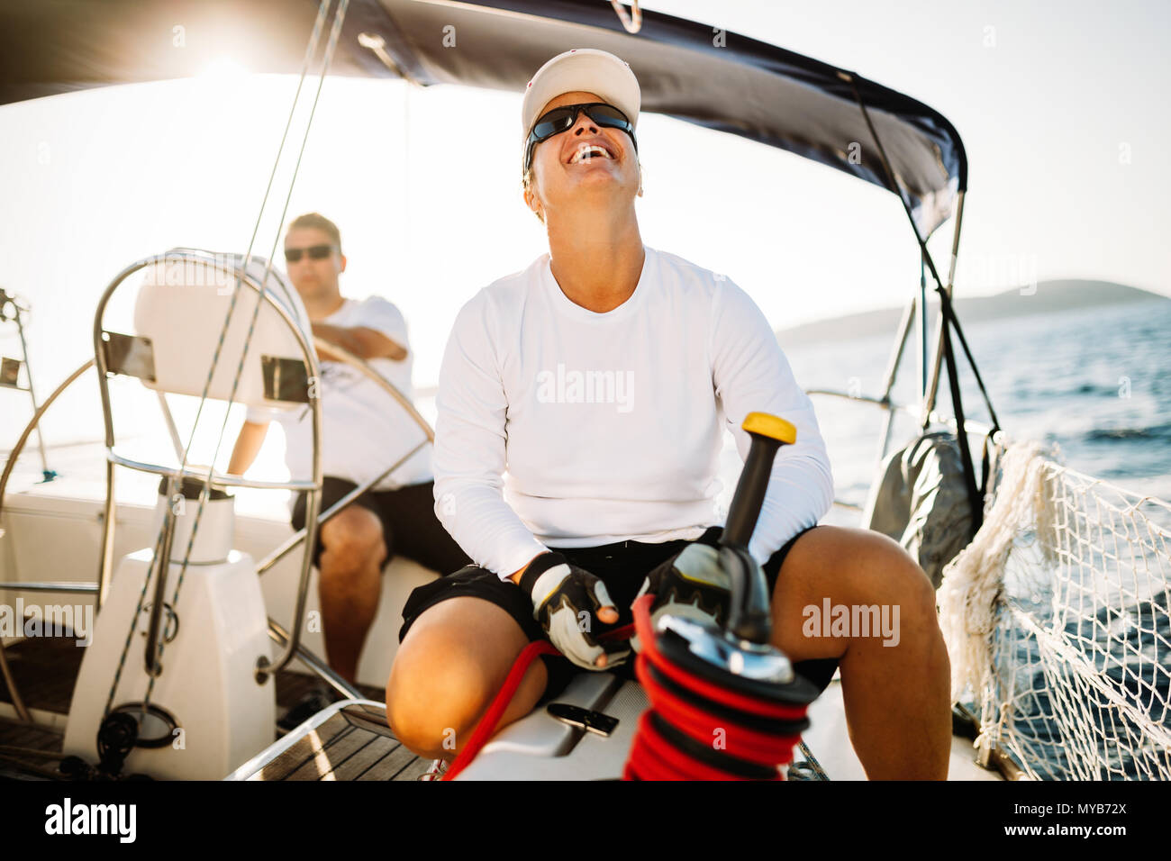 Attractive strong woman sailing with her boat Stock Photo - Alamy