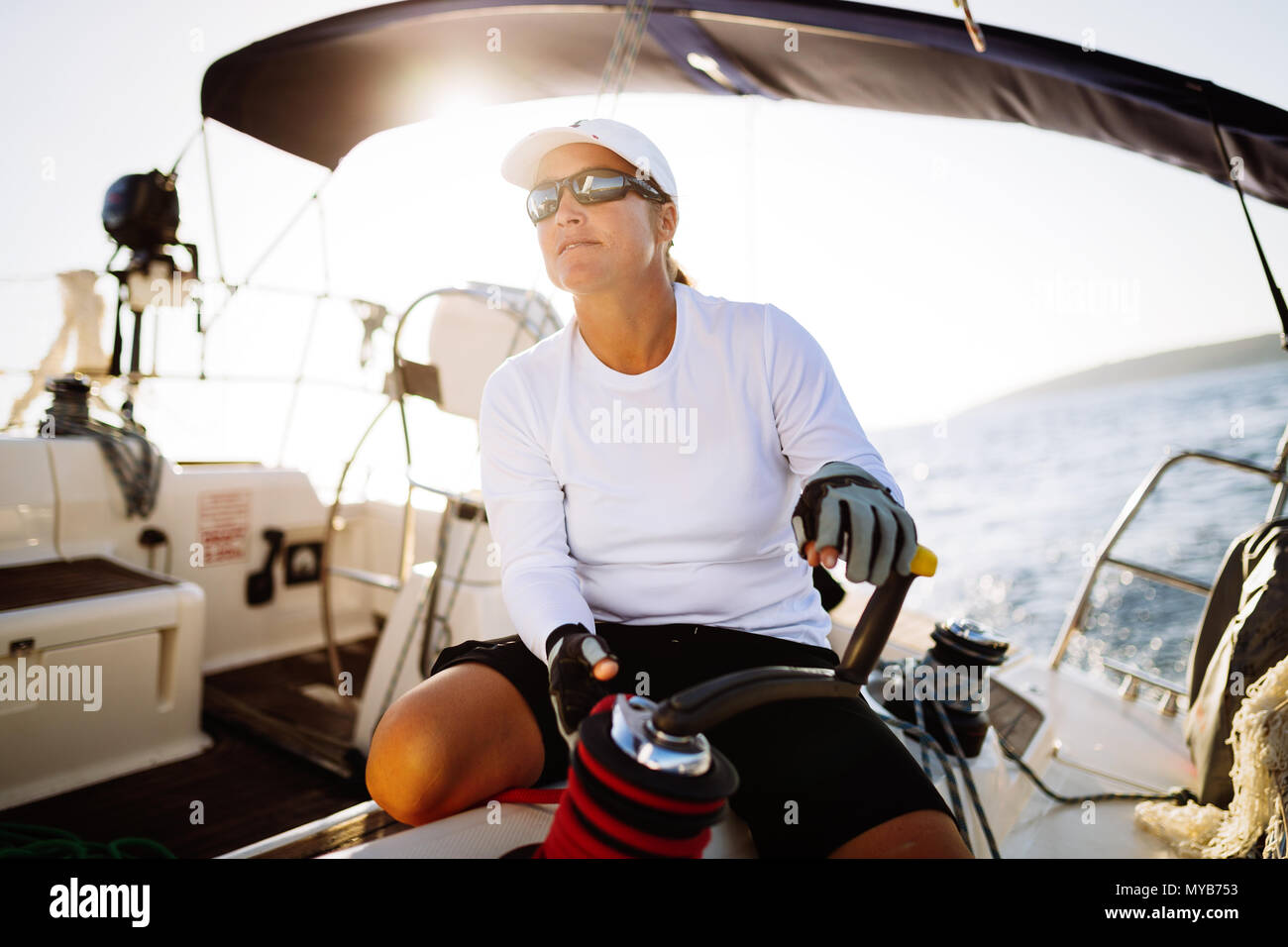 Attractive strong woman sailing with her boat Stock Photo - Alamy