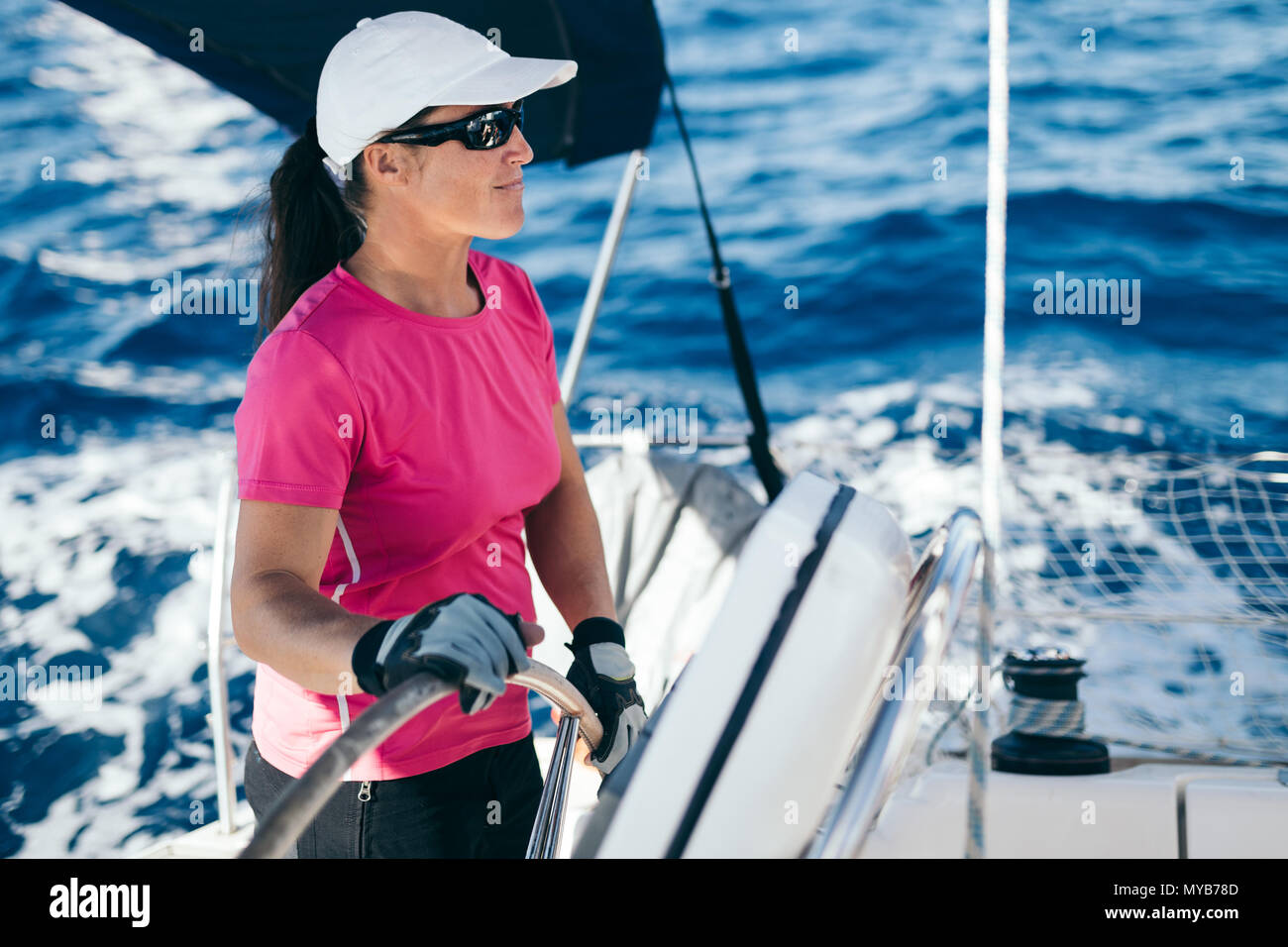 Female ship captain steering boat hi-res stock photography and images ...