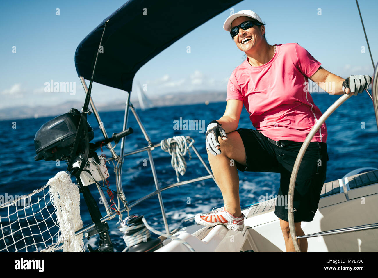 Happy strong woman sailing with her boat Stock Photo - Alamy
