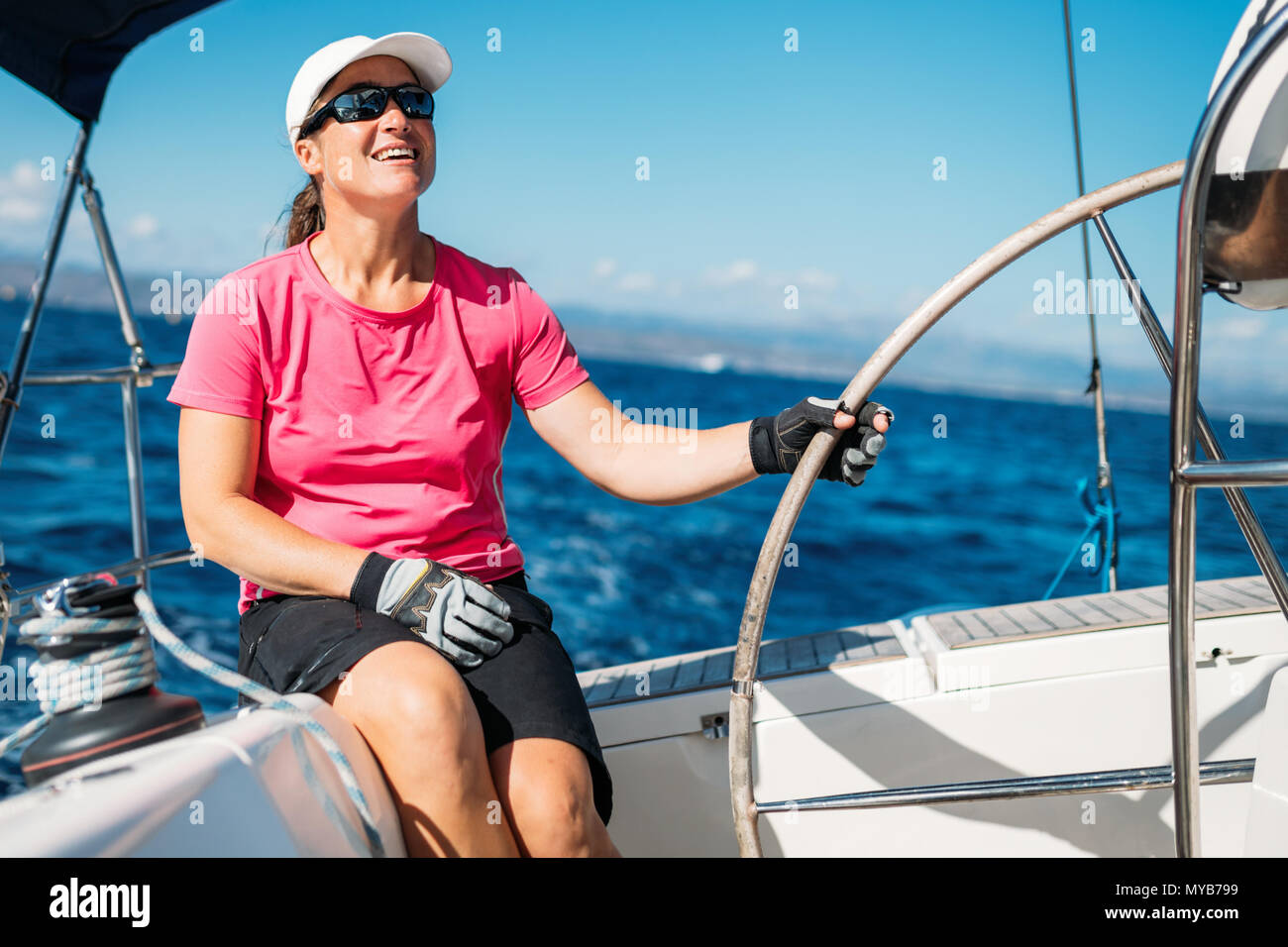 Happy strong woman sailing with her boat Stock Photo - Alamy