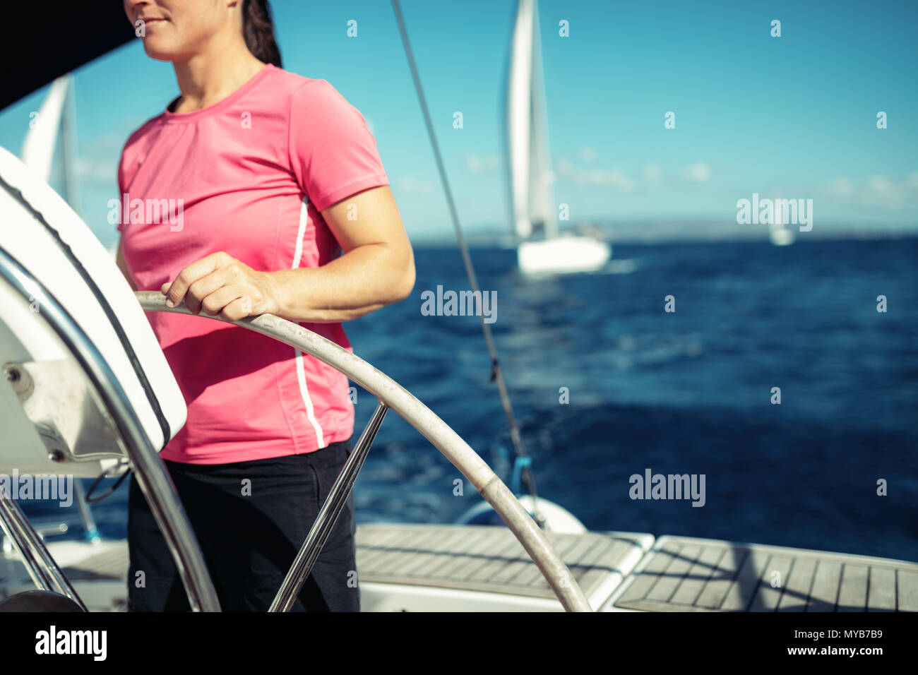 Happy strong woman sailing with her boat Stock Photo - Alamy