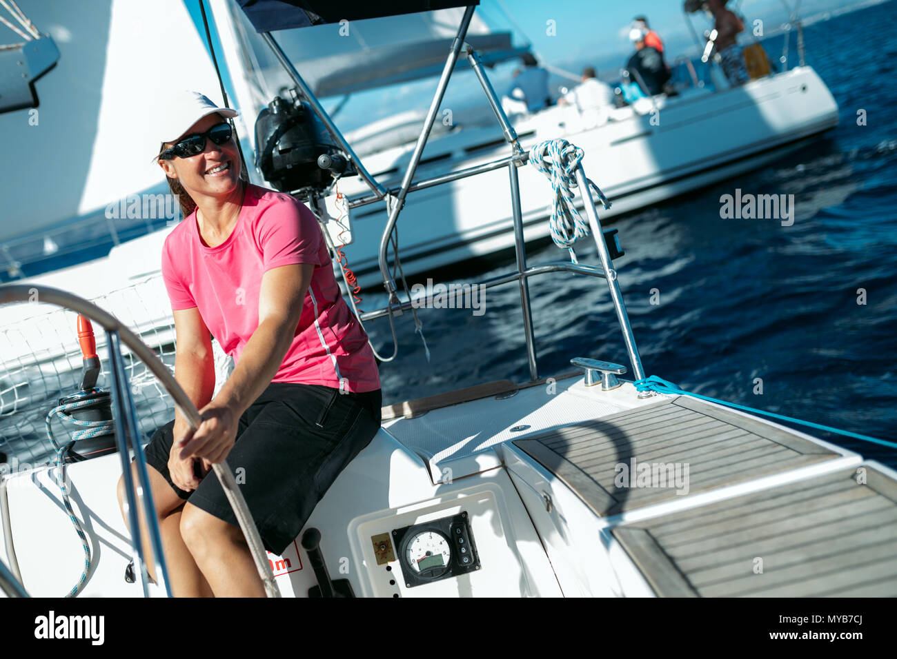 Happy strong woman sailing with her boat Stock Photo - Alamy