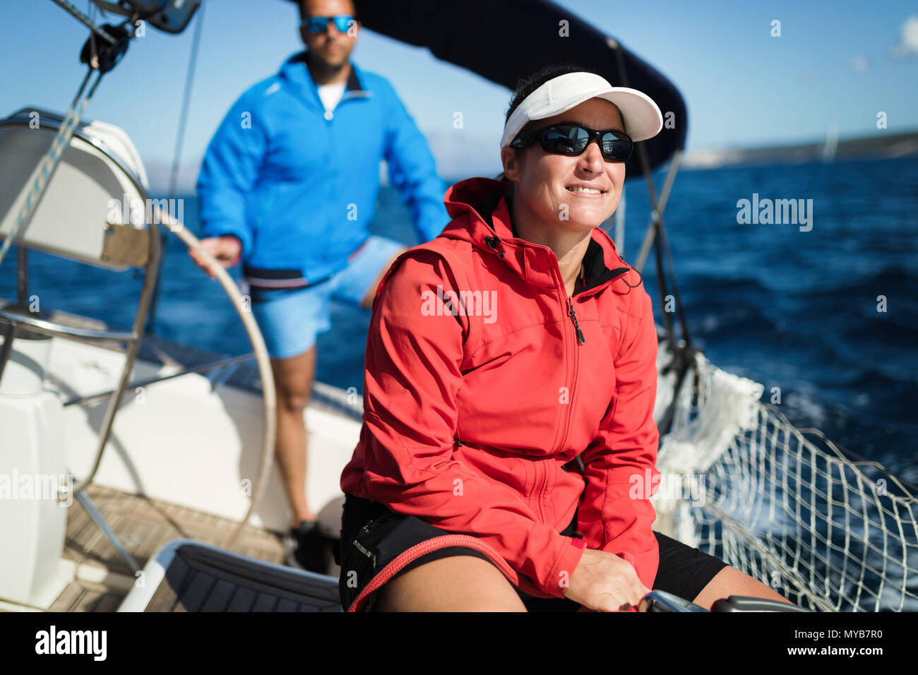 Attractive strong woman sailing with her boat Stock Photo - Alamy