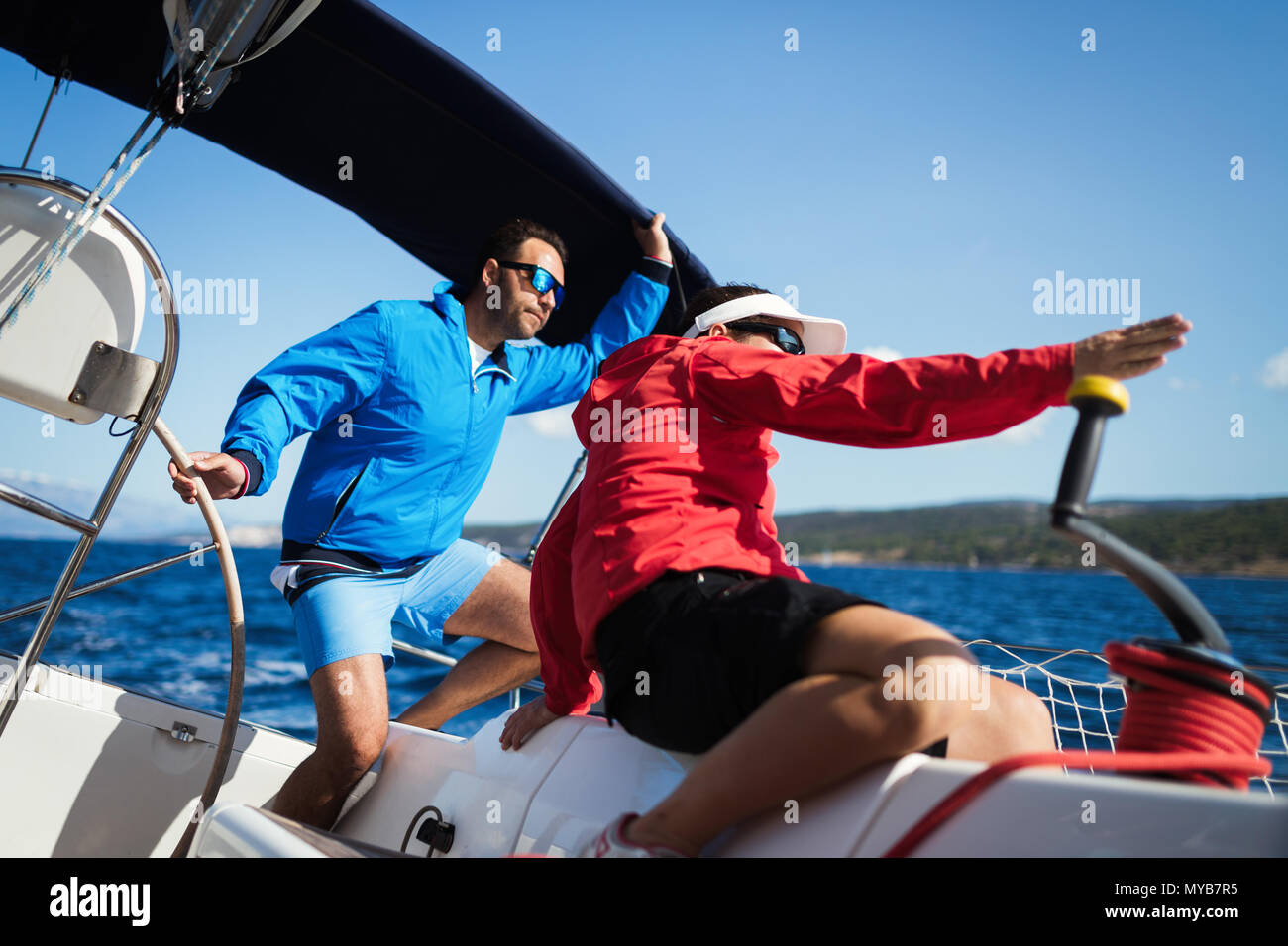 Attractive strong woman sailing with her boat Stock Photo - Alamy