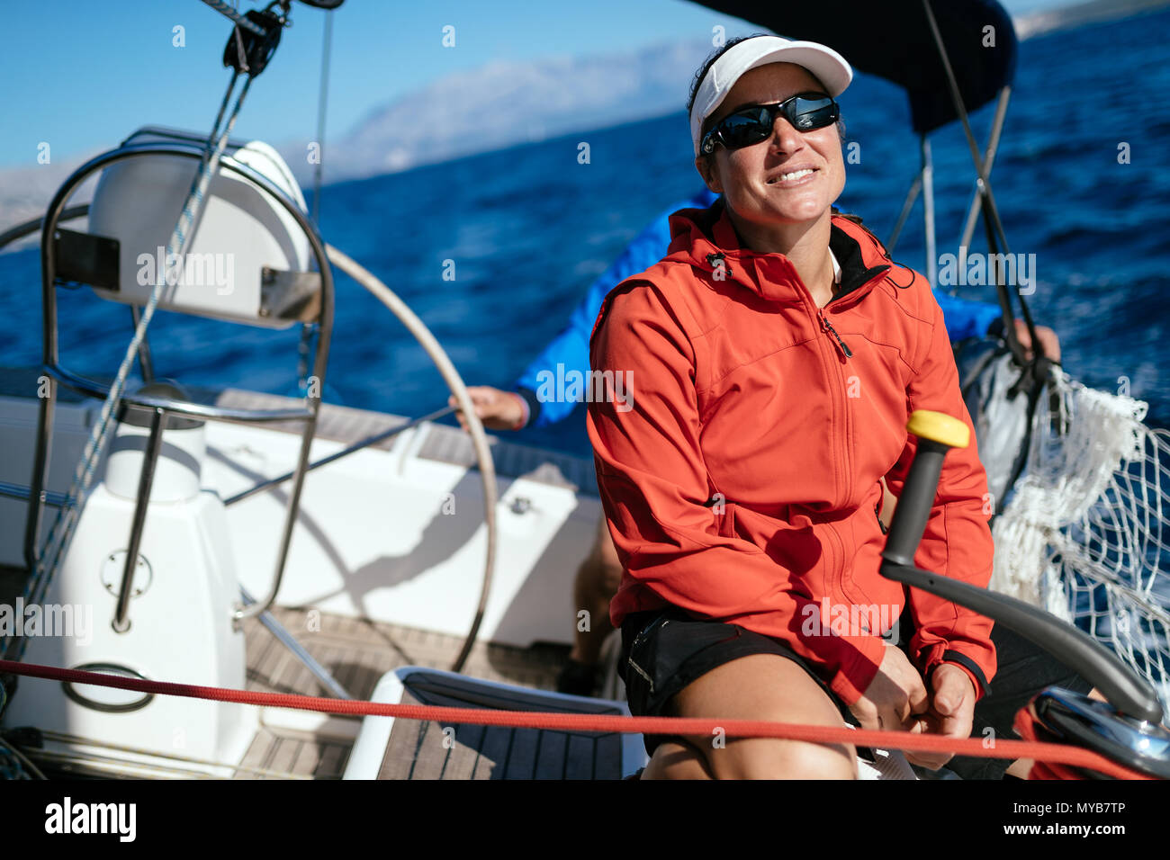 Attractive strong woman sailing with her boat Stock Photo - Alamy
