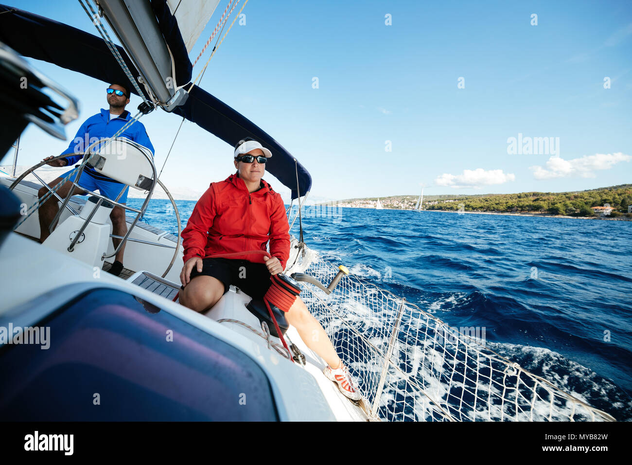 Attractive strong woman sailing with her boat Stock Photo - Alamy
