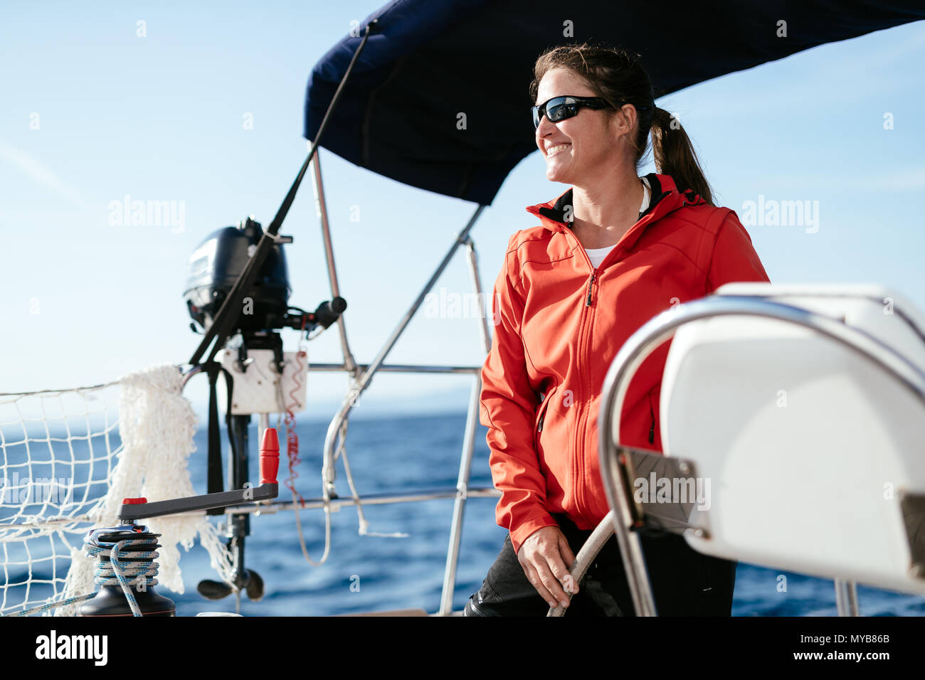 Attractive strong woman sailing with her boat Stock Photo - Alamy