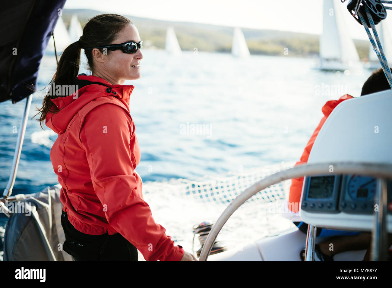 Attractive strong woman sailing with her boat Stock Photo - Alamy