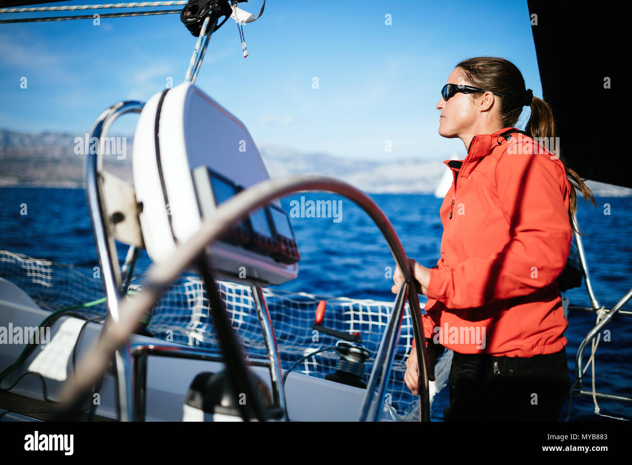 Attractive strong woman sailing with her boat Stock Photo - Alamy