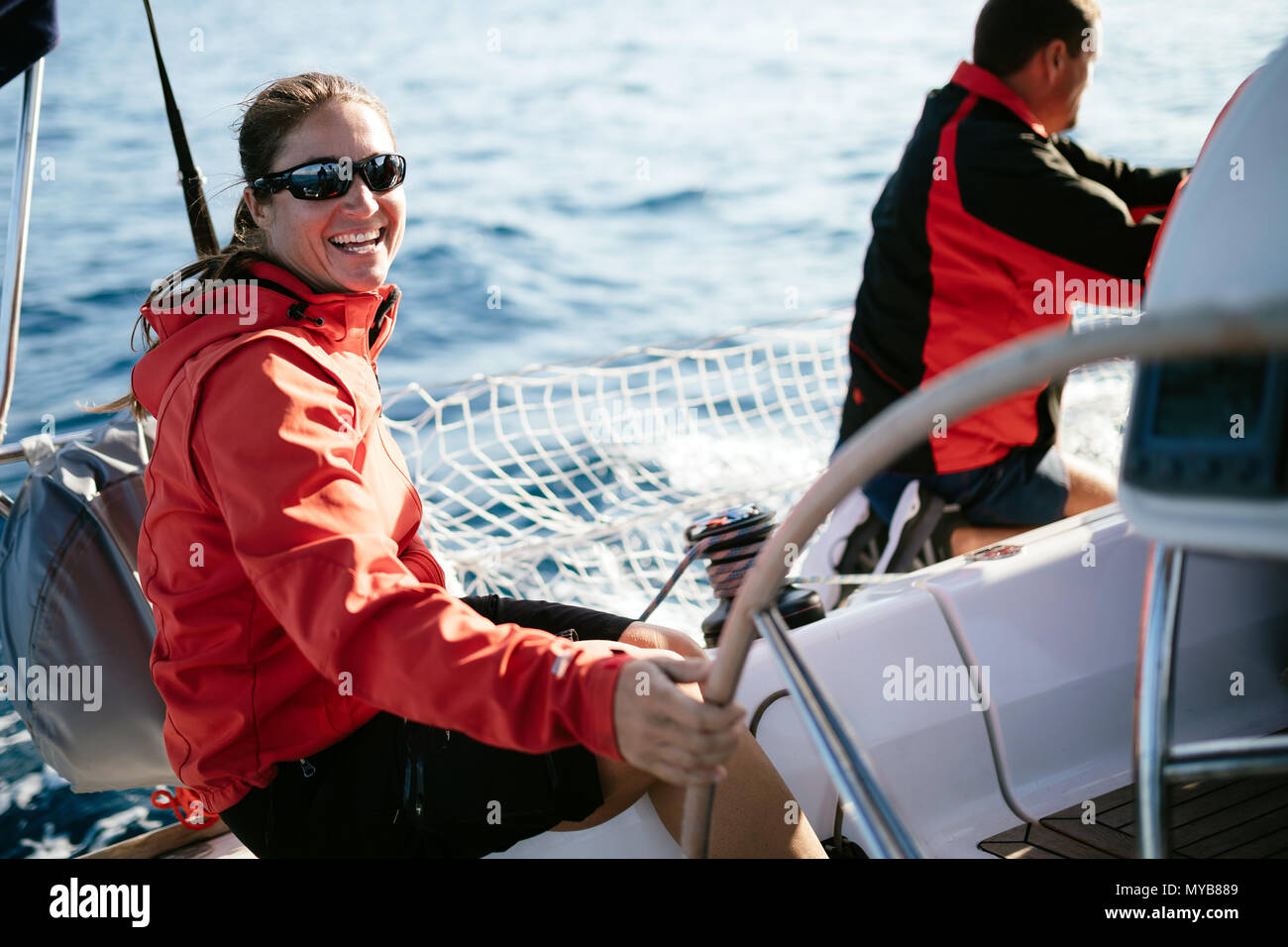 Attractive strong woman sailing with her boat Stock Photo - Alamy