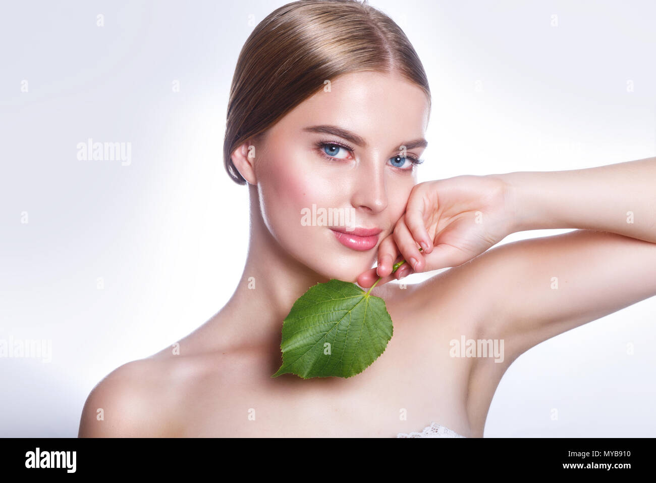Beautiful Woman Face Portrait With Green Leaf Concept For Skin Care Or